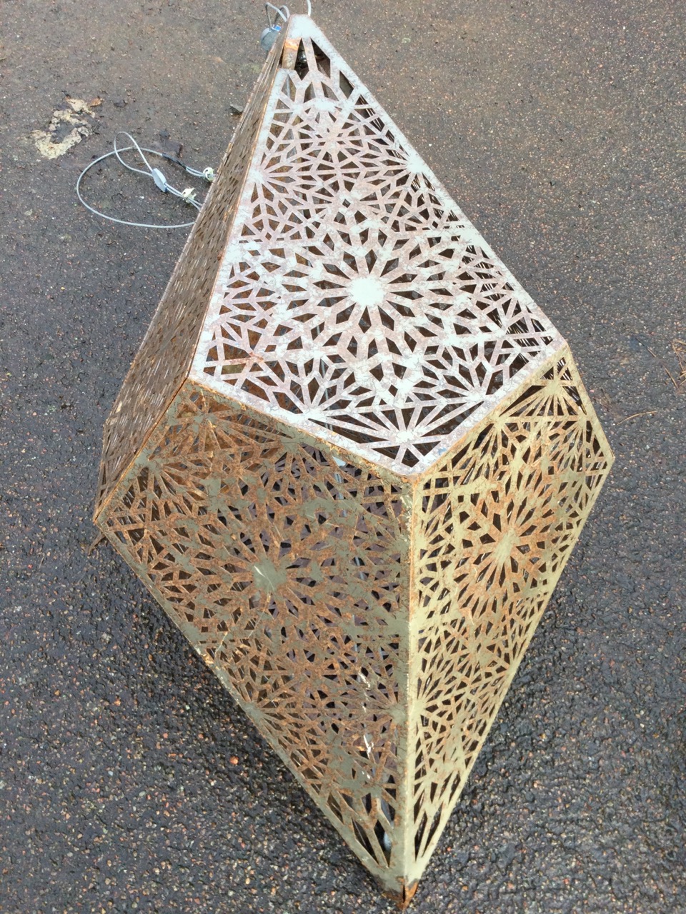 A set of three diamond shaped metal pentagonal hanging lanterns, with ...