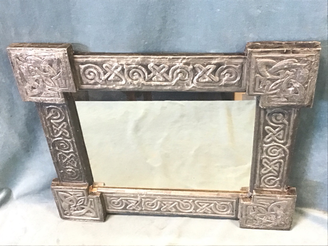 An arts & crafts pewter mounted mirror with embossed entwined celtic ...