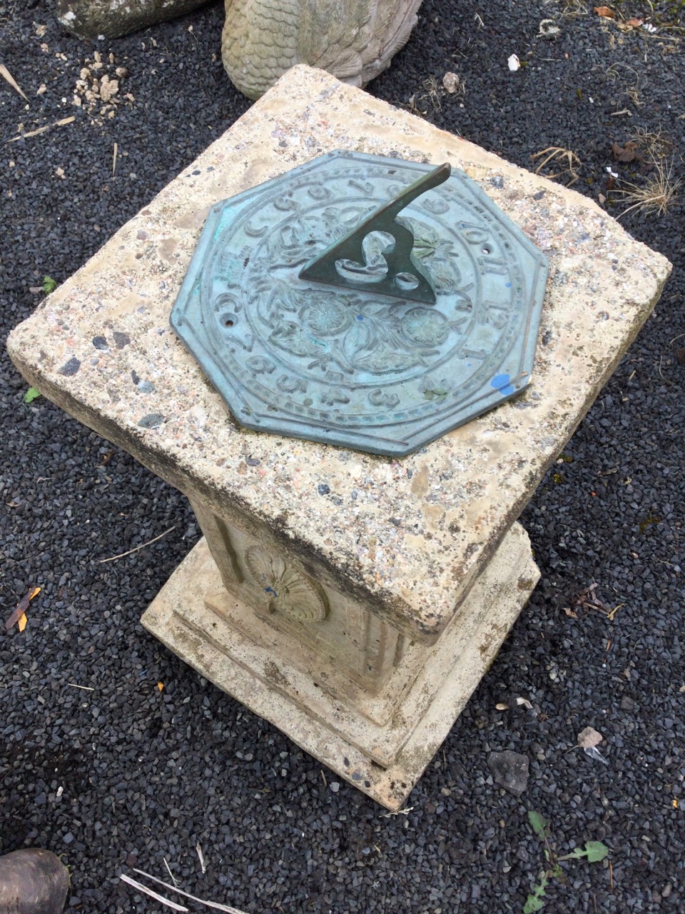 A composition stone garden sundial with octagonal panel cast with ...