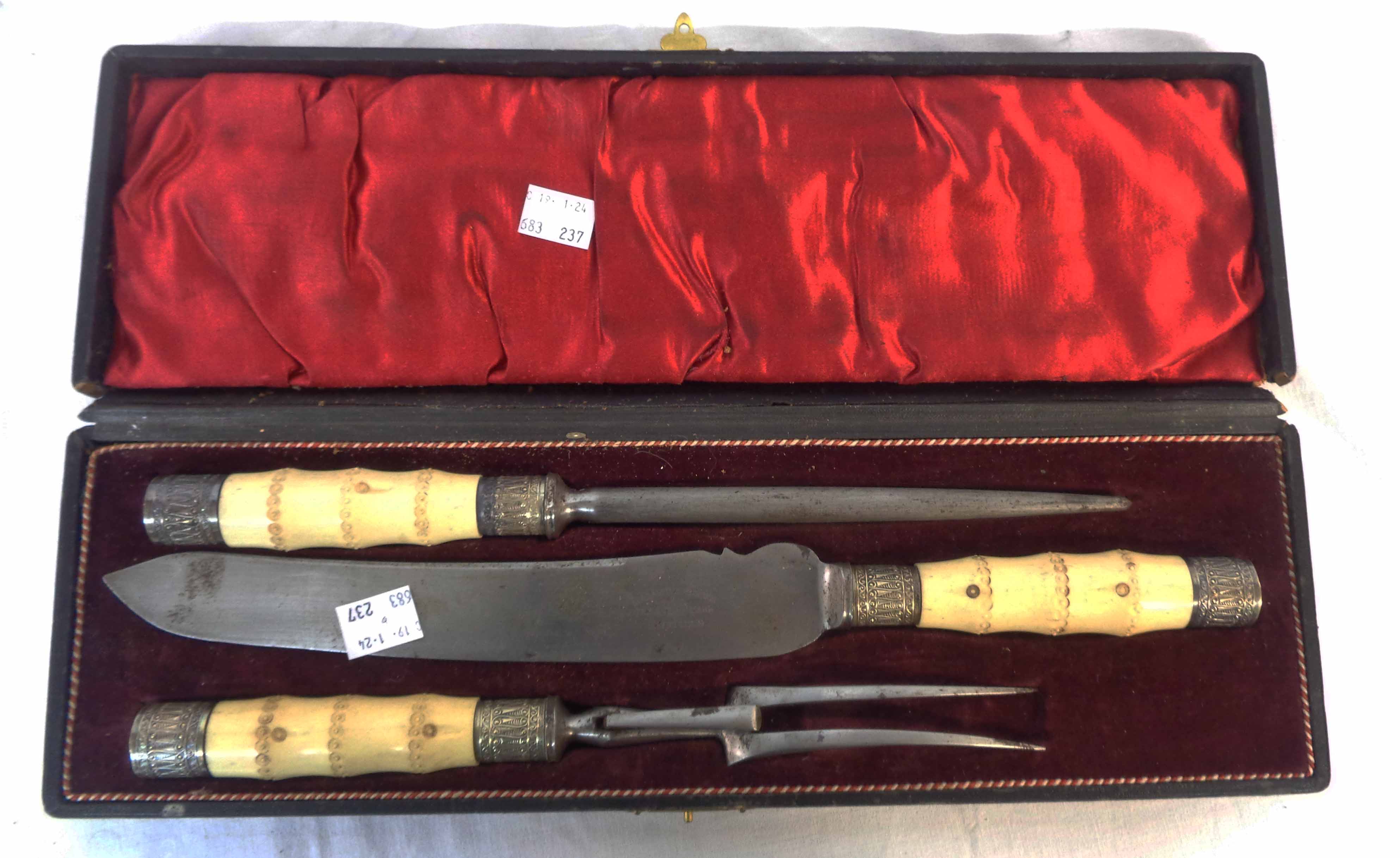A cased antique three piece carving set with turned bone handles and ...