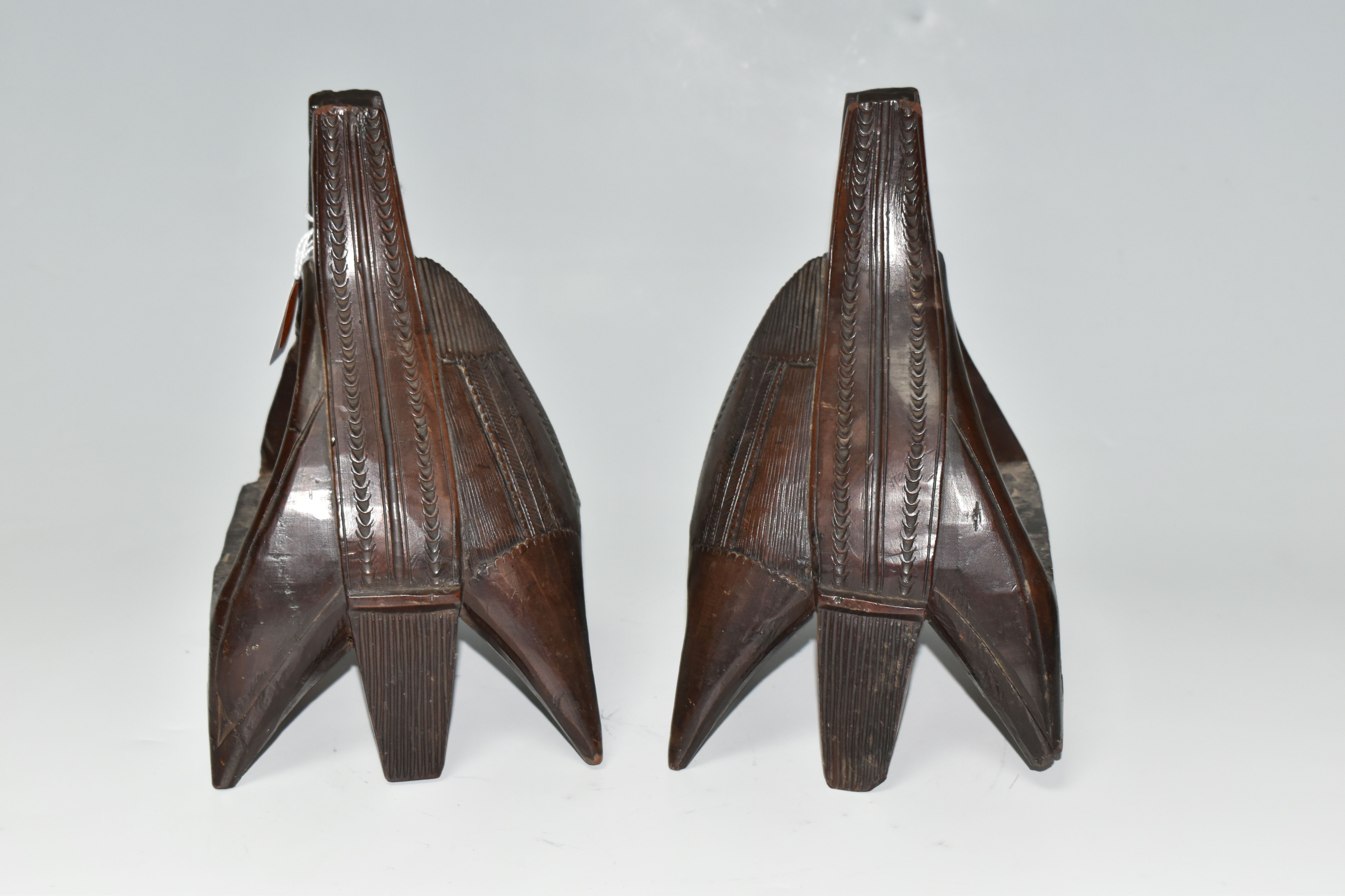 A PAIR OF WOODEN STIRRUPS, carved with patterns, each with six wooden ...