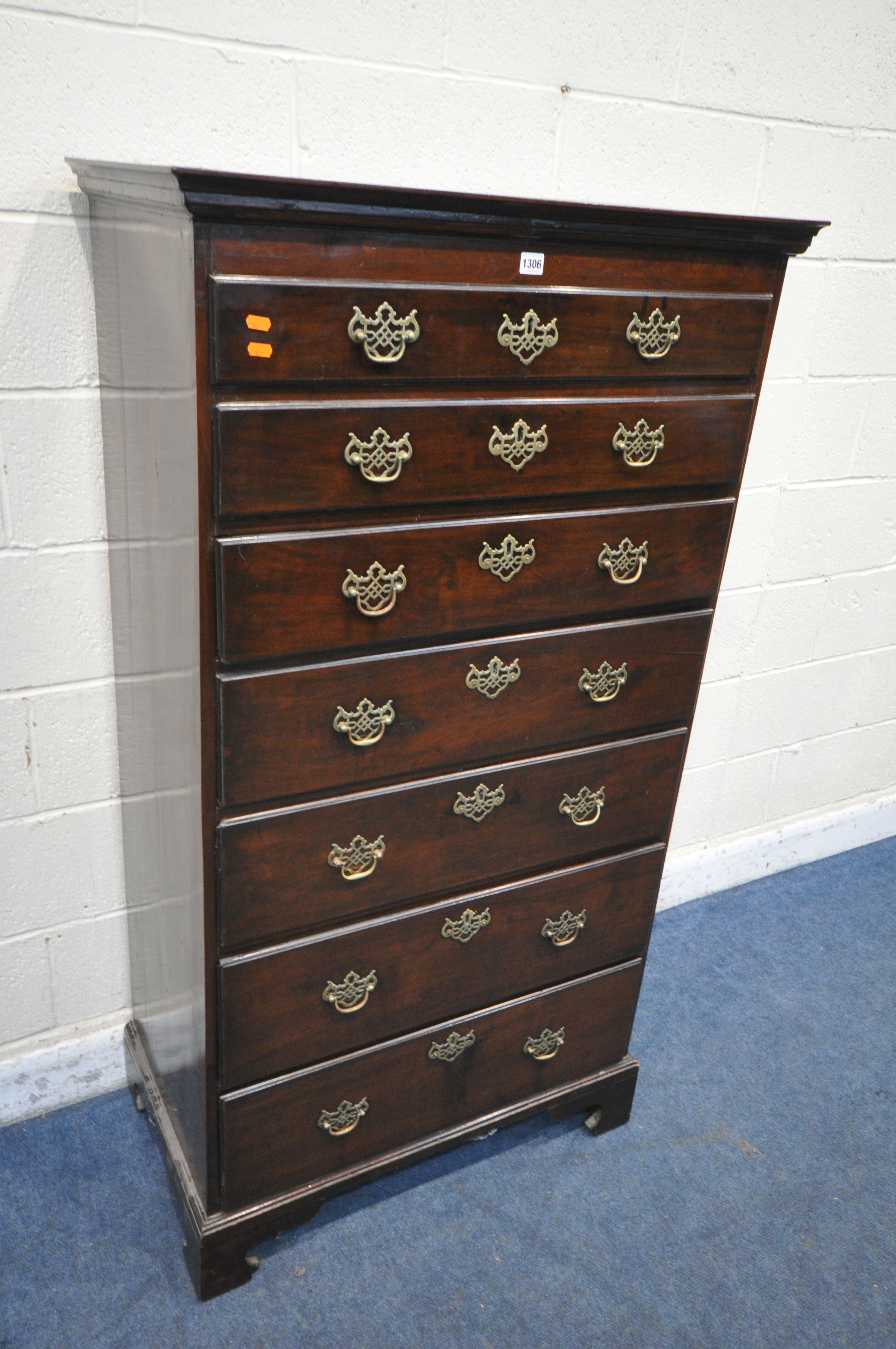 A GEORGIAN MAHOGANY TALL CHEST OF SEVEN GRADUATED DRAWERS, on bracket ...
