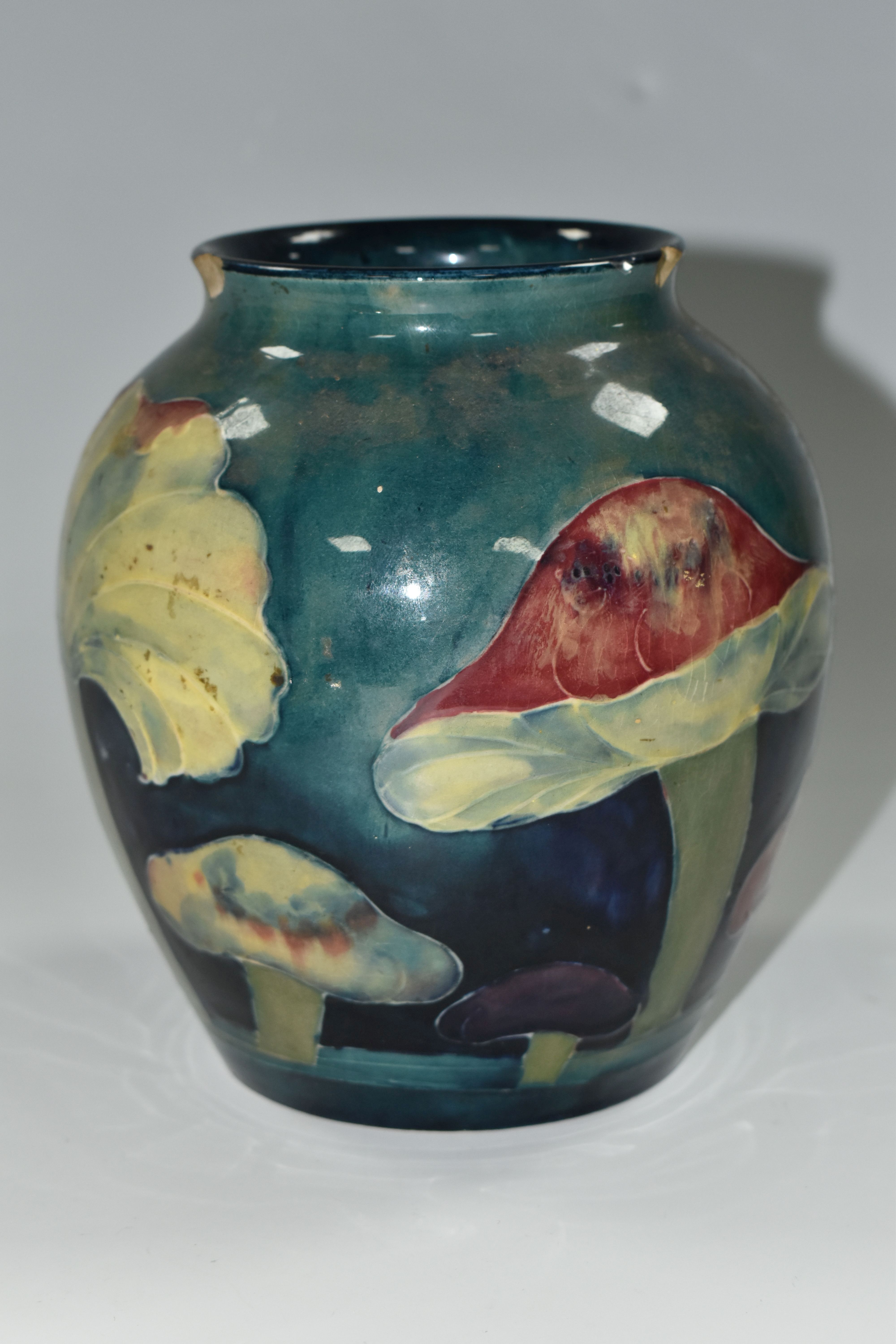 A MOORCROFT POTTERY 'CLAREMONT' DESIGN VASE, a red, green and purple ...