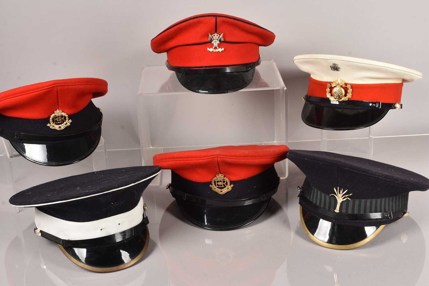 A collection of Military peak caps, from various Regiments and Ranks ...