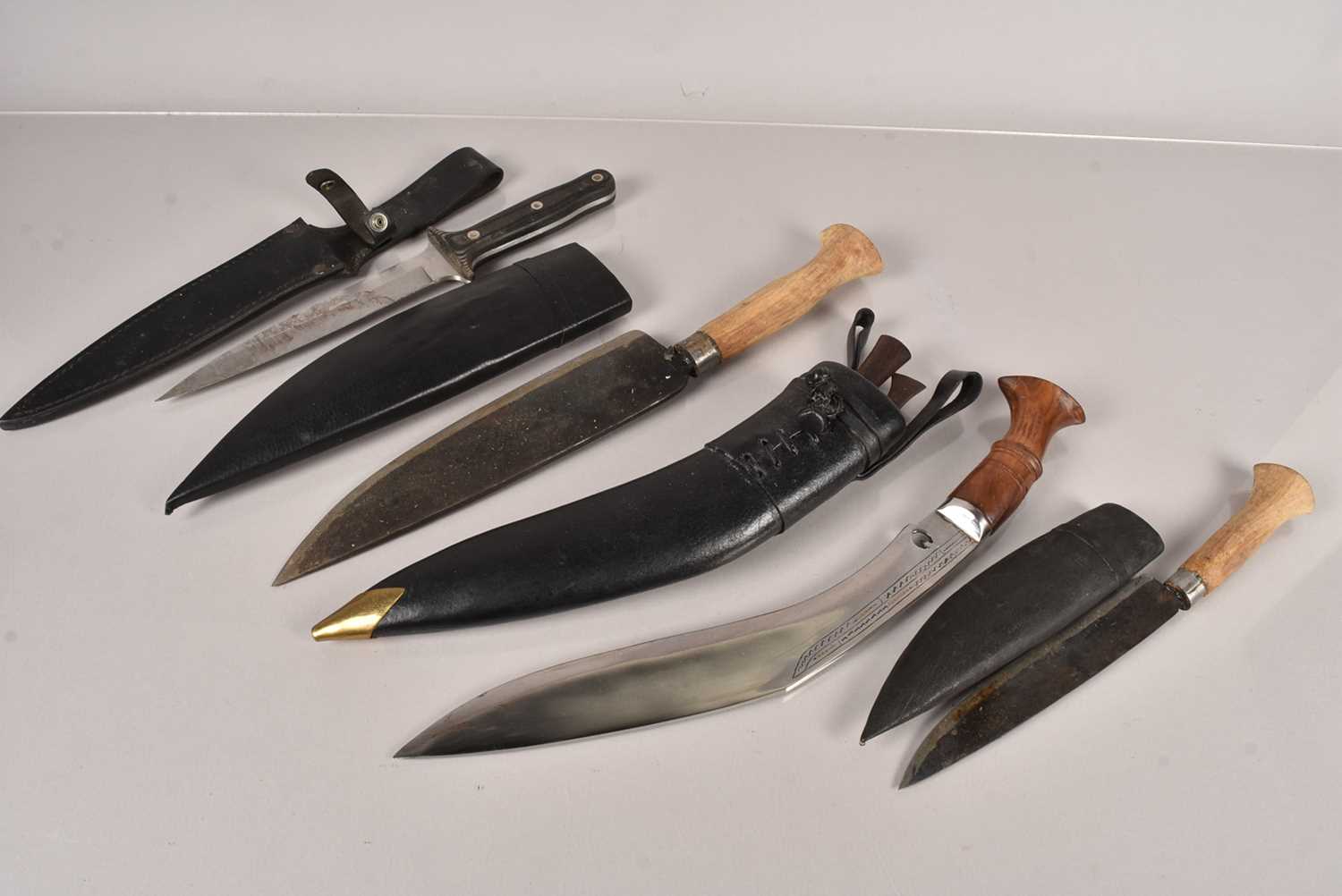 A Middle Eastern Style Kukri knife, complete with scabbard and two ...