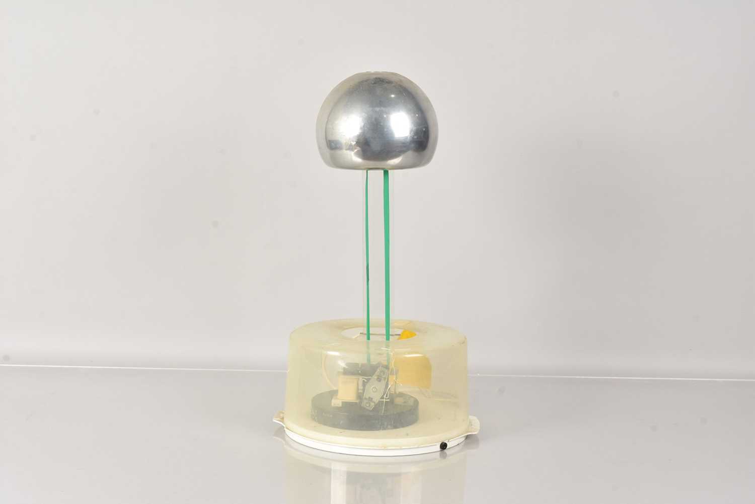 A Van De Graaf Generator, having metal sphere to the top, with green ...