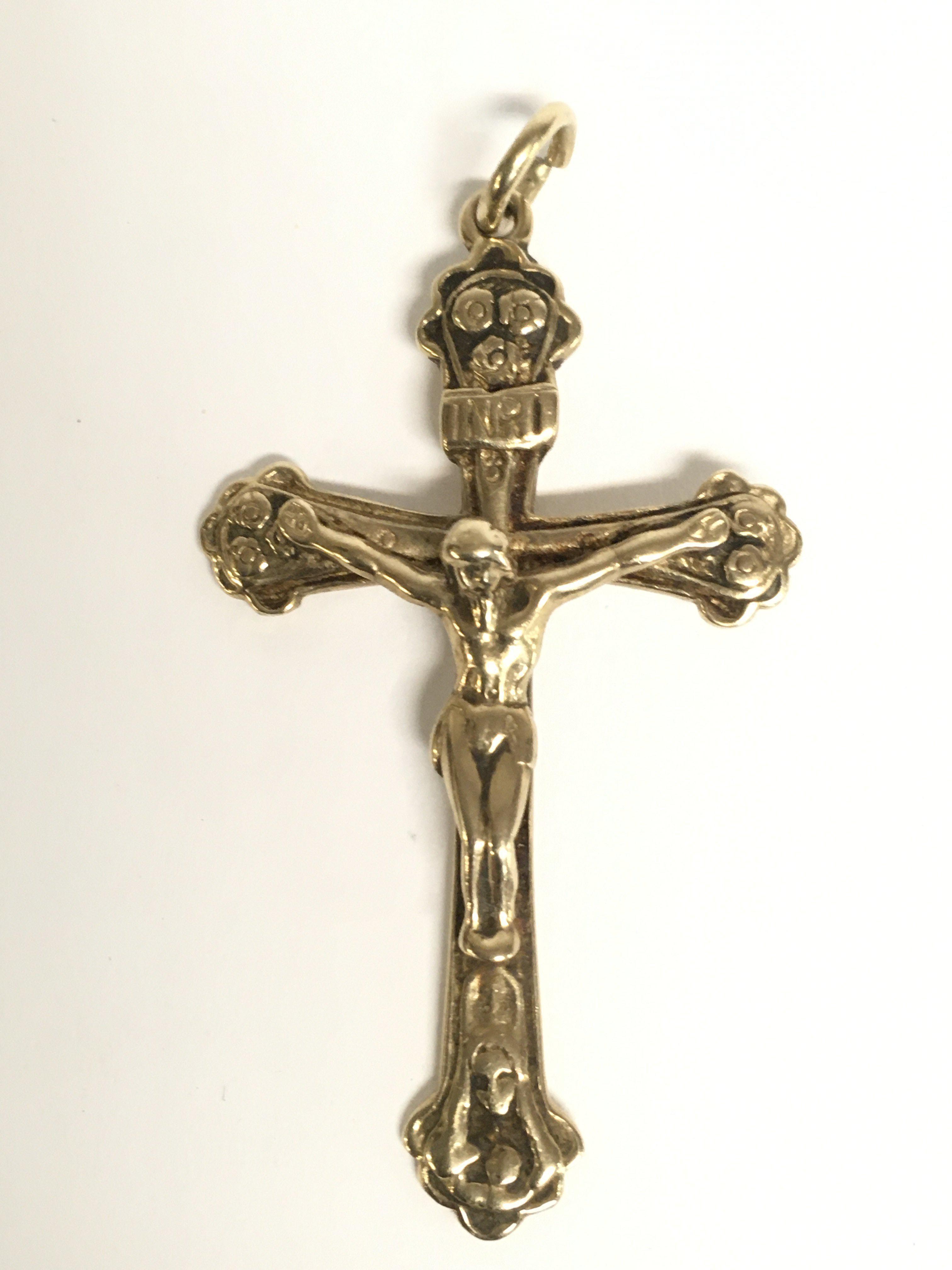 A 9ct gold cross pendant. Approximately 6cm long. 10.1g Postage category A