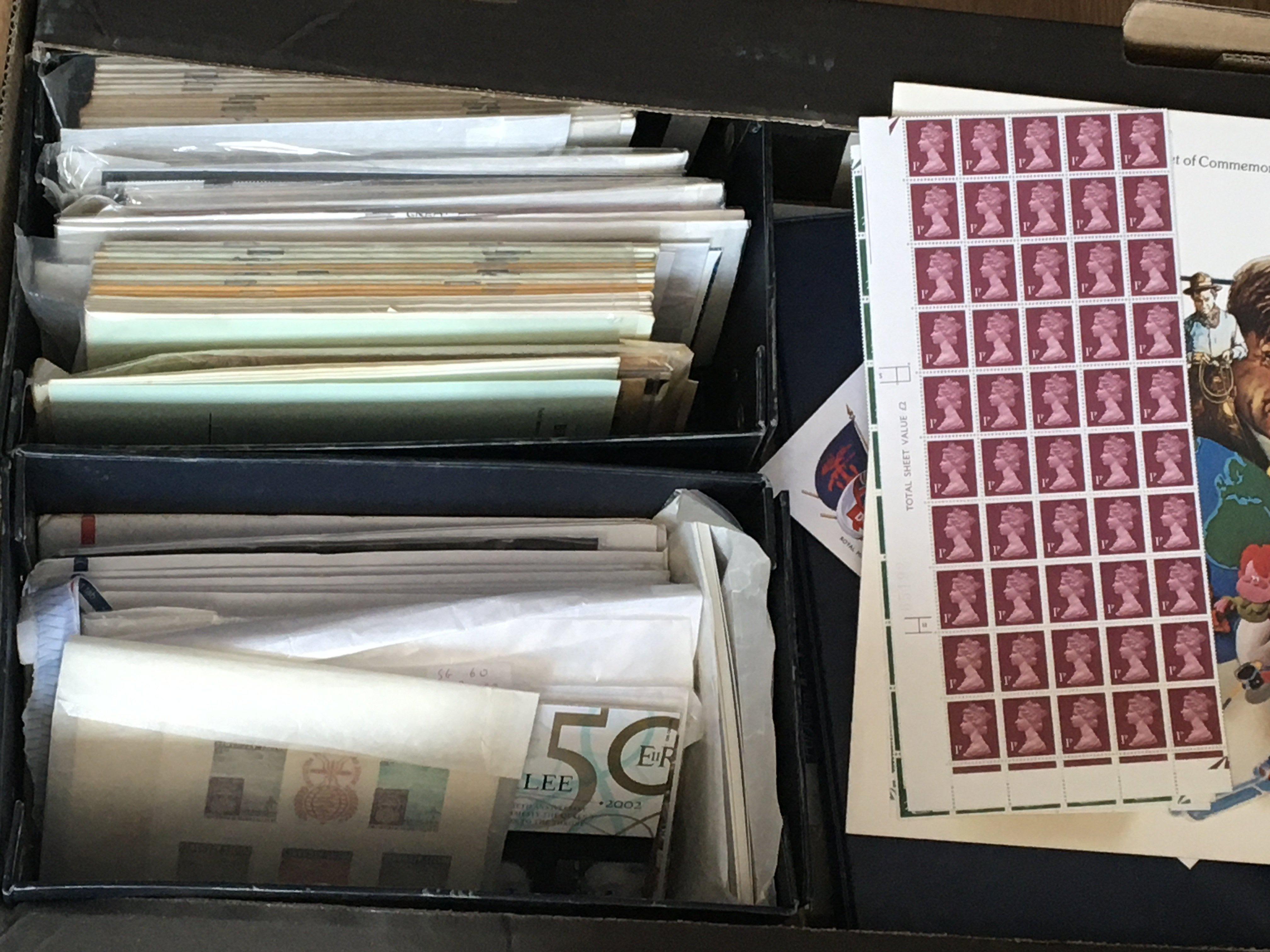 A box containing stamp albums presentation packs and .philatelic covers