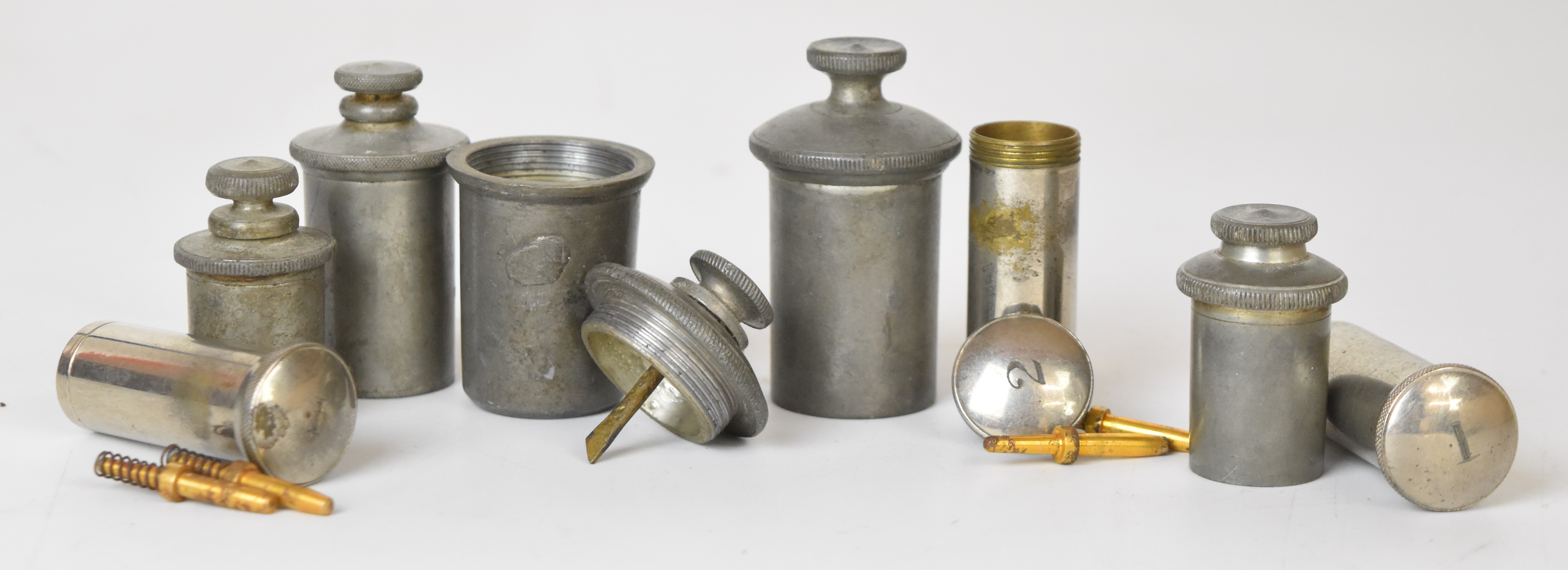 Eight gun case oil bottles including a numbered pair, G & J W Hawksley ...