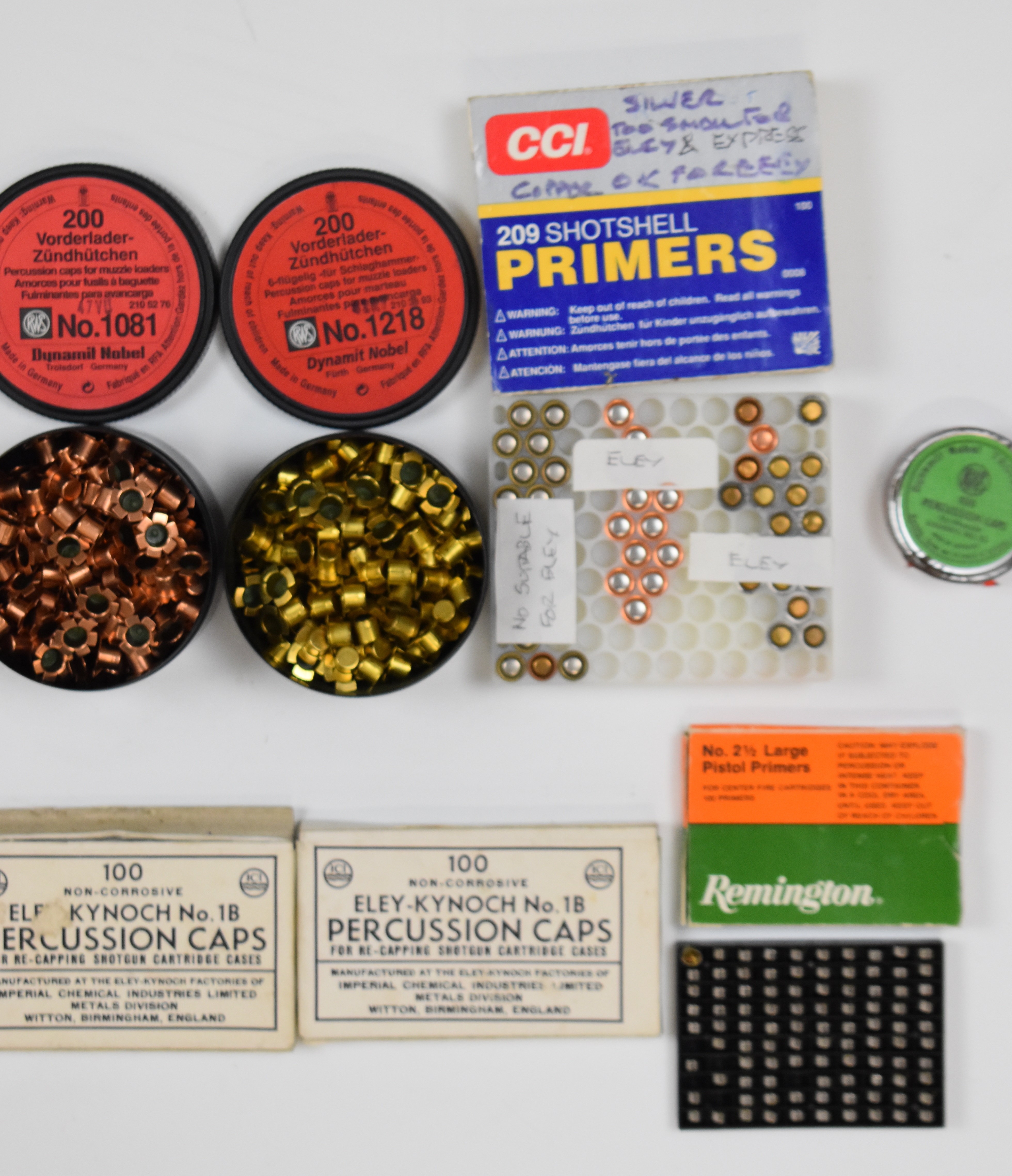 A large collection of percussion caps and cartridge primers including ...