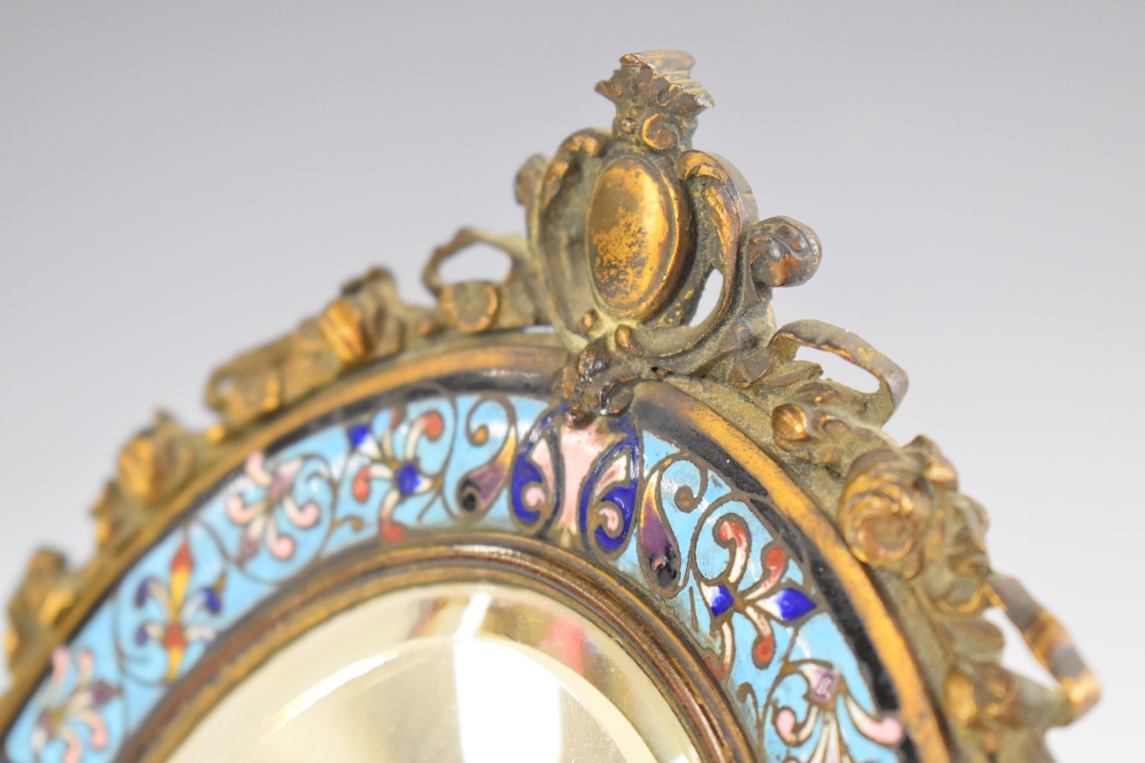 A 19thC brass and champlevé enamel easel back bevelled glass mirror ...
