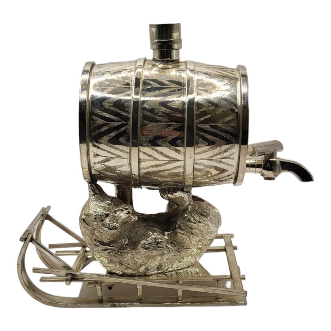 A SILVER PLATED BRANDY BARRELSupported by a bear on a sledge, impressed ...