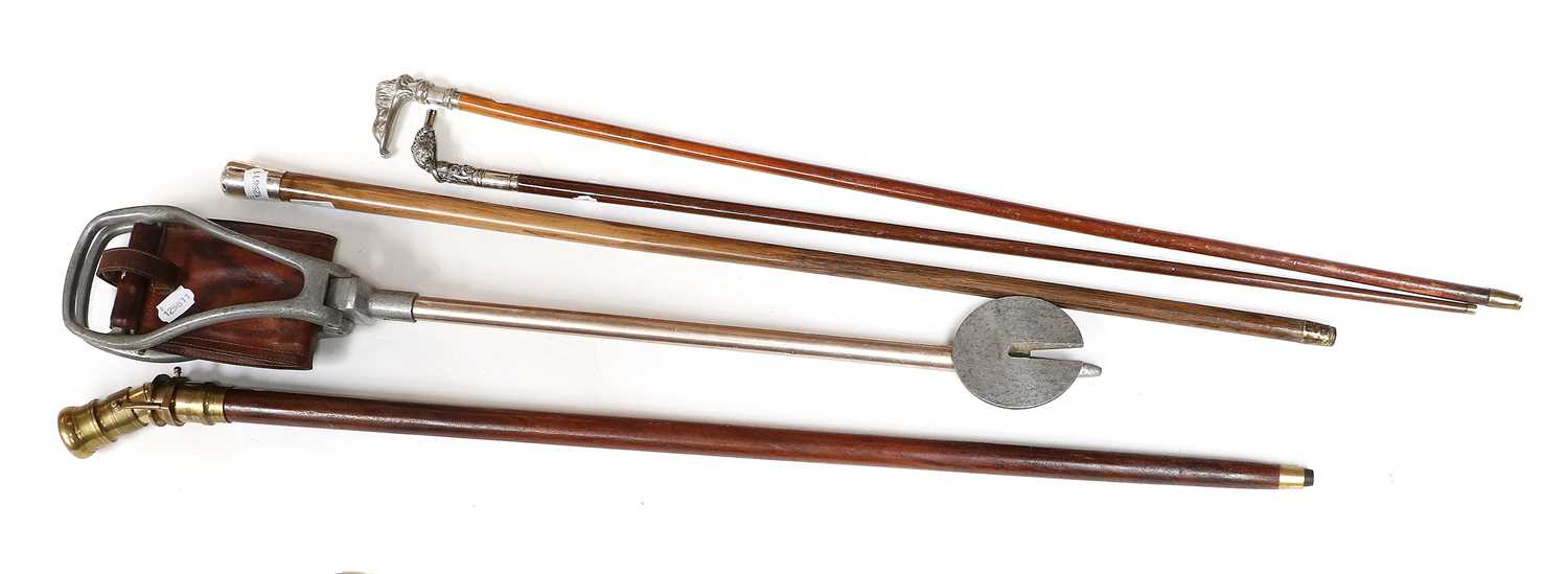 A Silver Topped Cane, two white metal swagger sticks, brass mounted ...