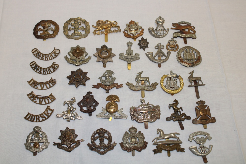 A selection of approximately 30 various military cap badges including ...