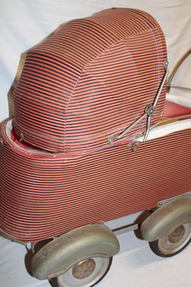 An unusual 1950's/60's four-wheel pram with collapsing hood