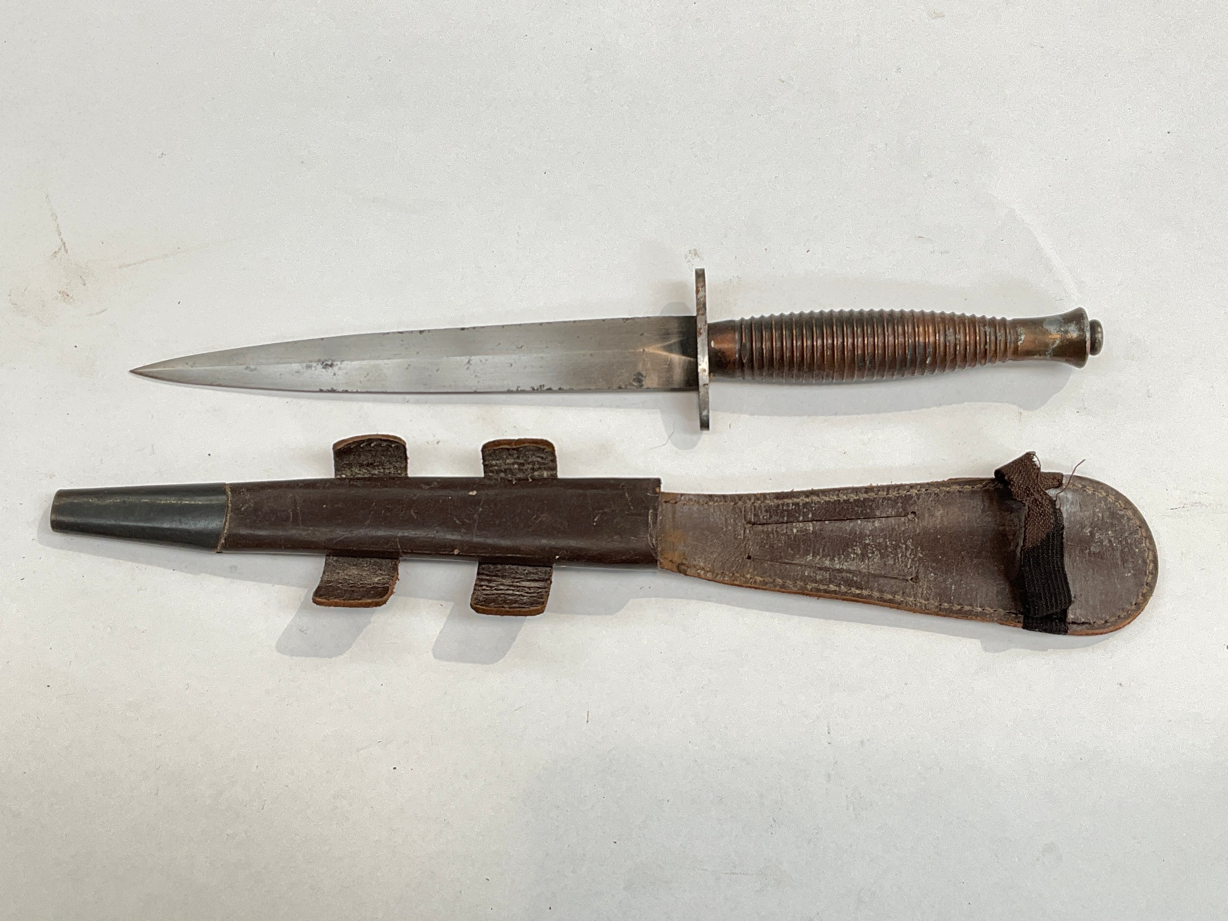 A Fairbairn Sykes third pattern commando dagger, with scabbard, the ...