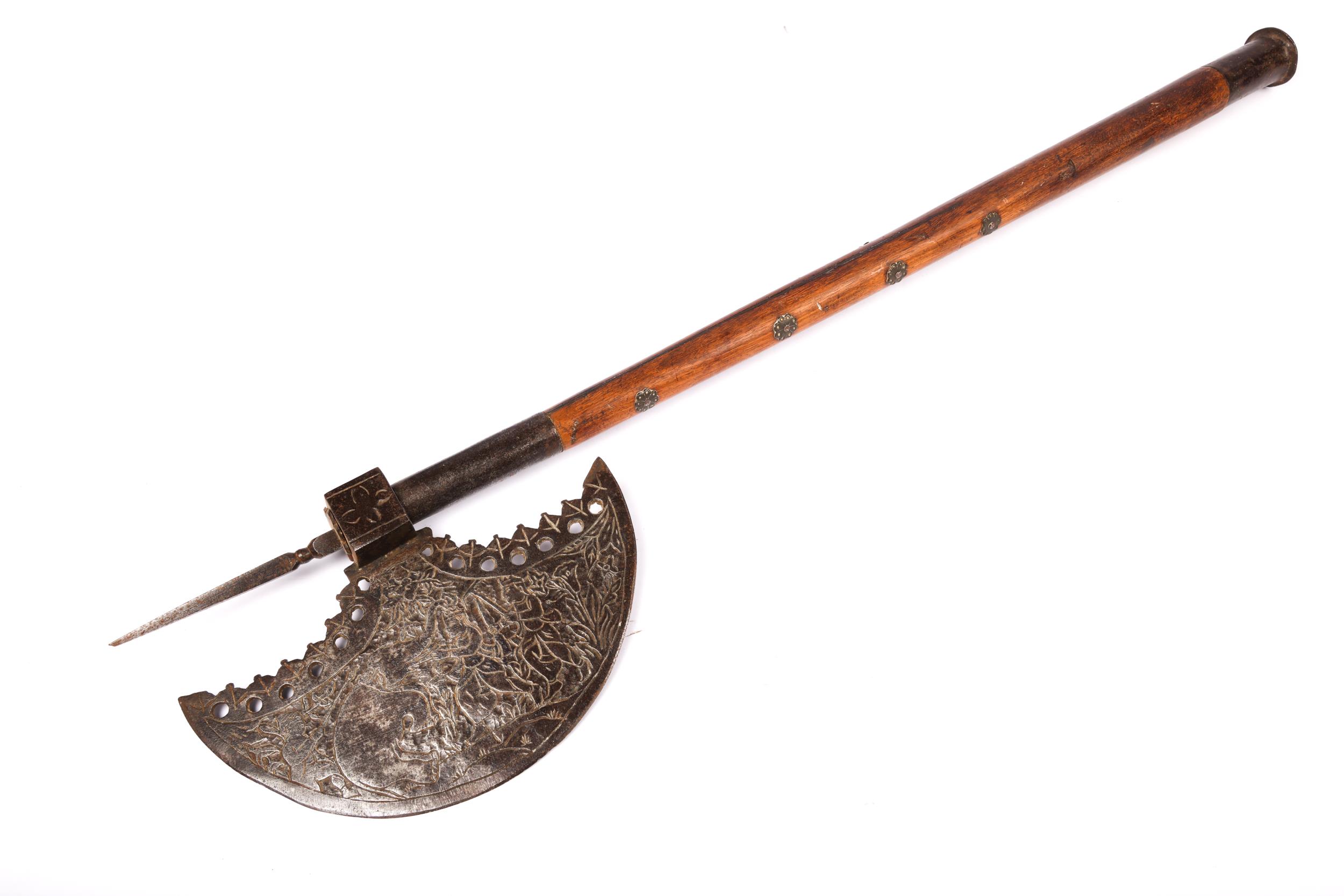 An Indian axe, the crescent head chiselled with an elephant and figures ...