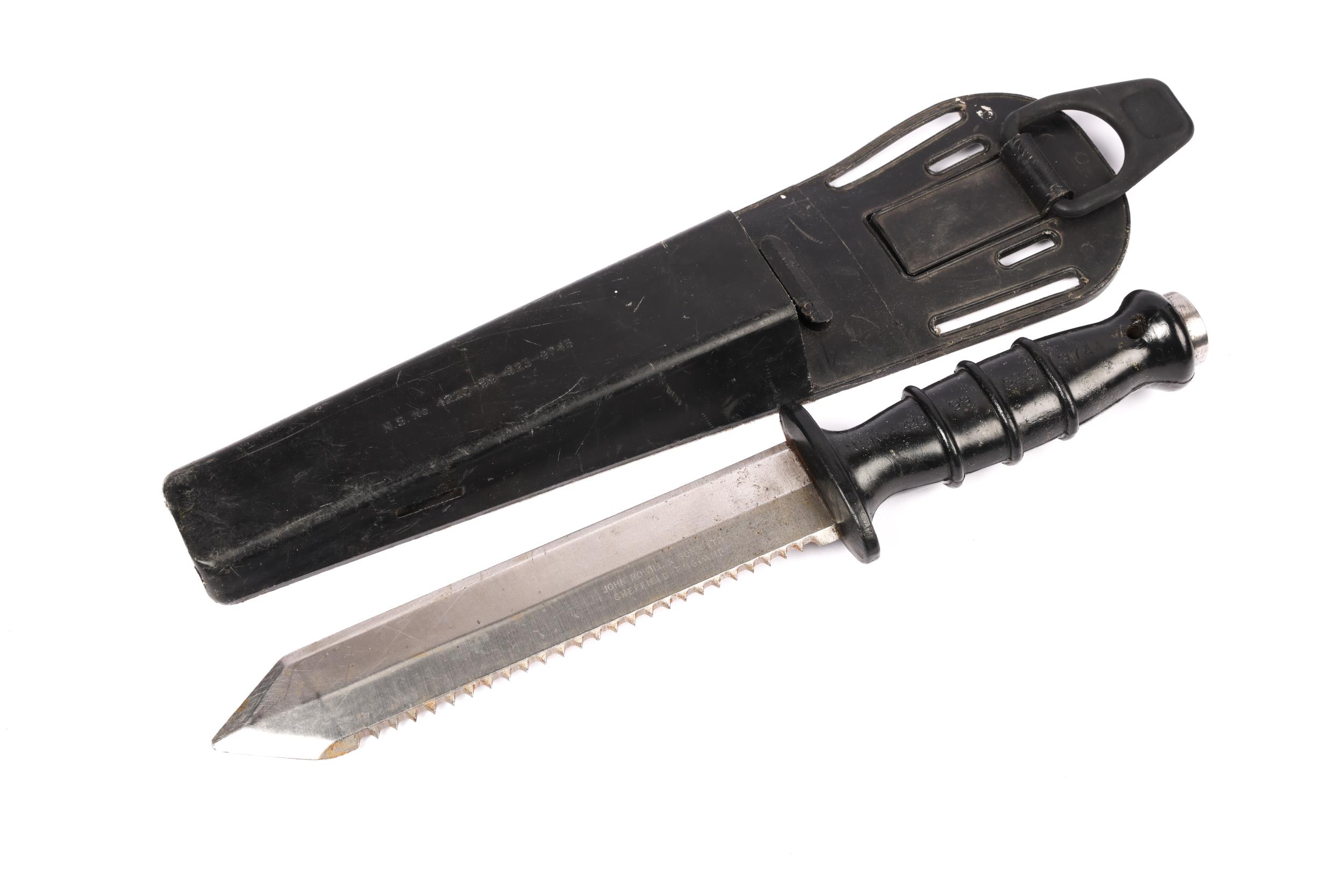 A British Royal Navy issue diver's knife, saw back blade 8", the black ...
