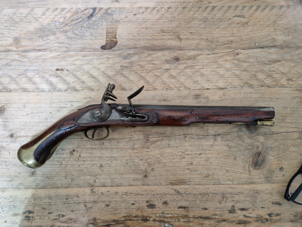 A pair of reproduction flintlock pistols, 31cm barrel with ramrod below ...