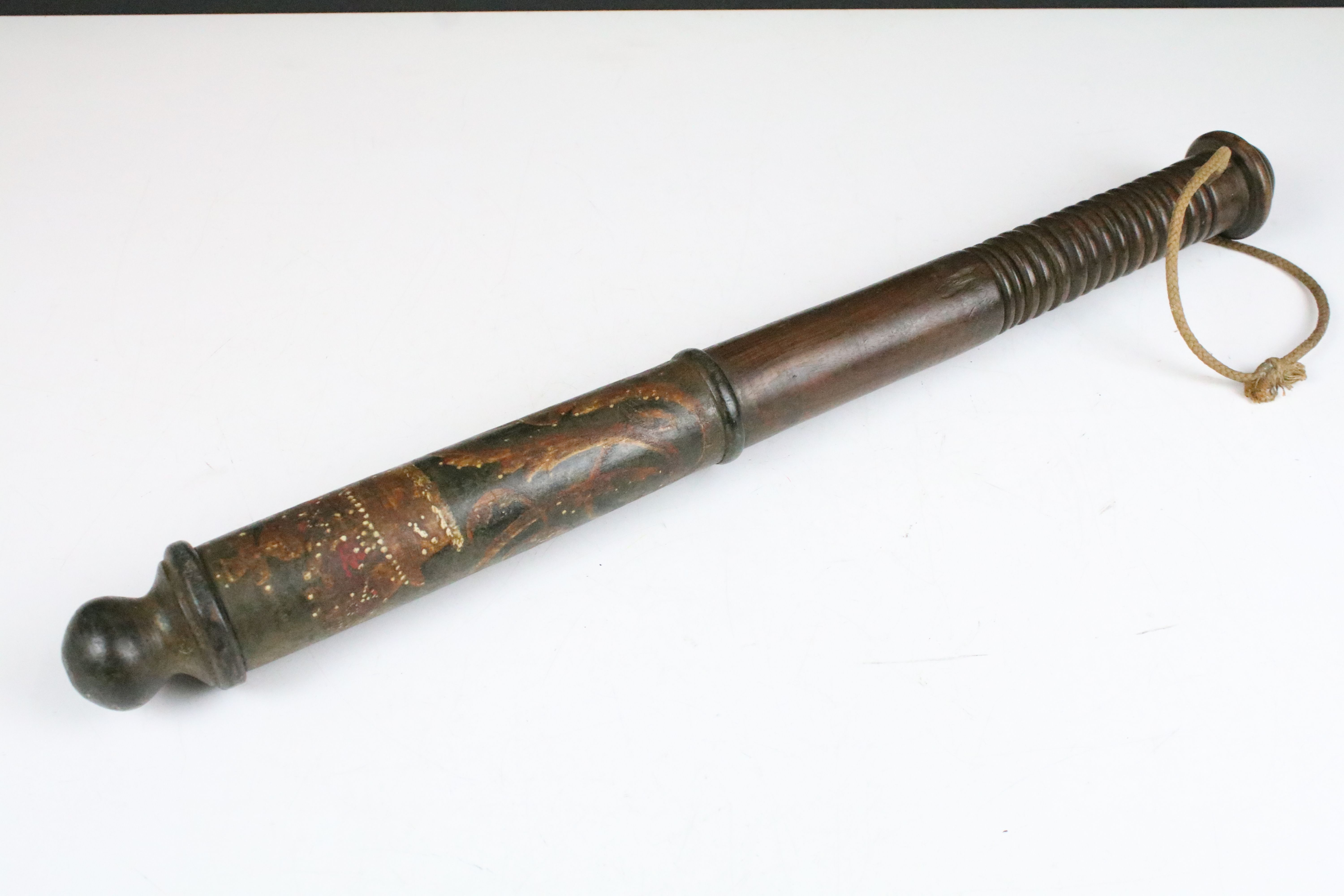 Two truncheons, the smaller with painted insignia, indistinct, possibly ...
