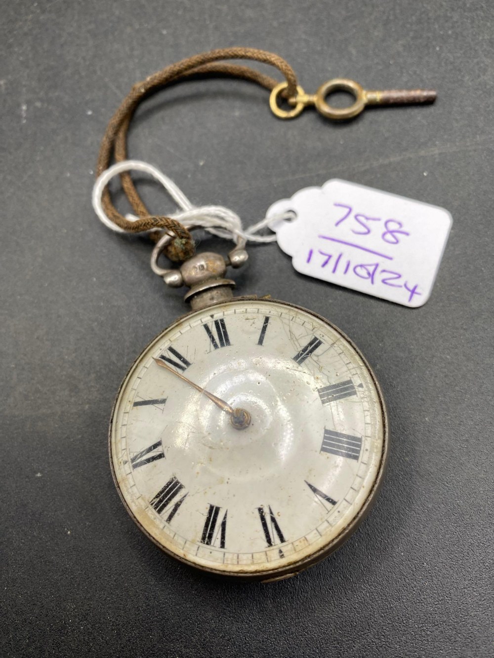 A 18th century silver pocket watch with outer case missing and key