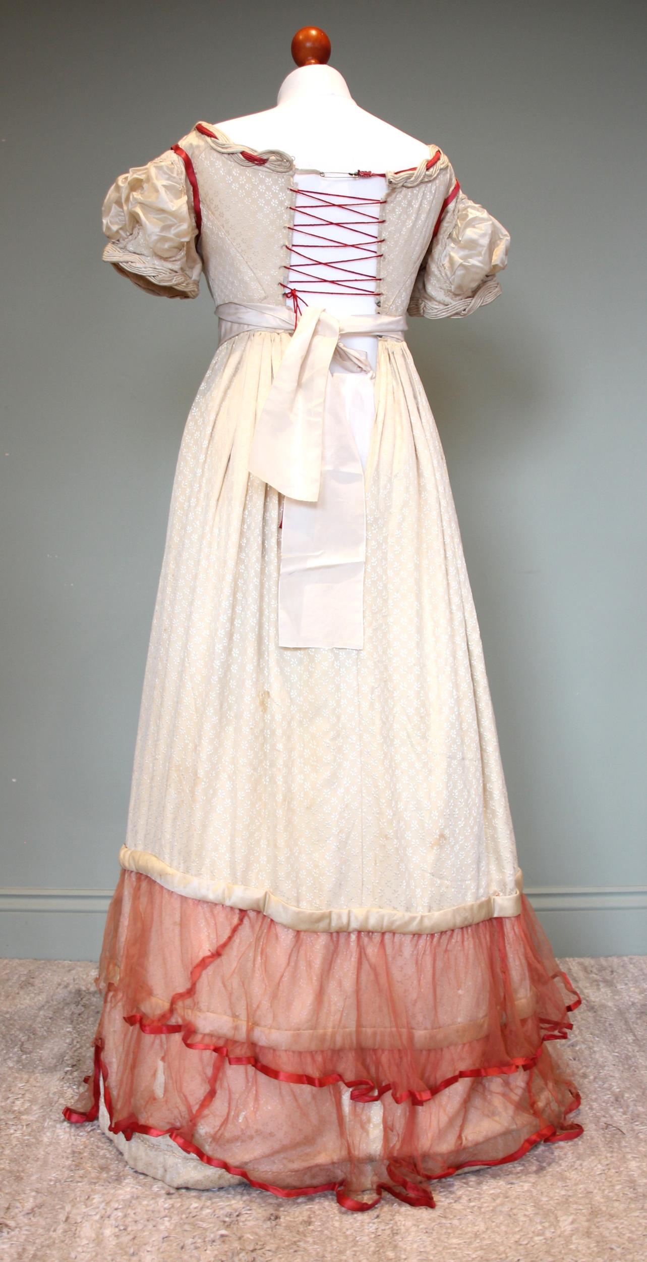 A Regency cream figured silk evening dress, circa 1815-1820, the short ...