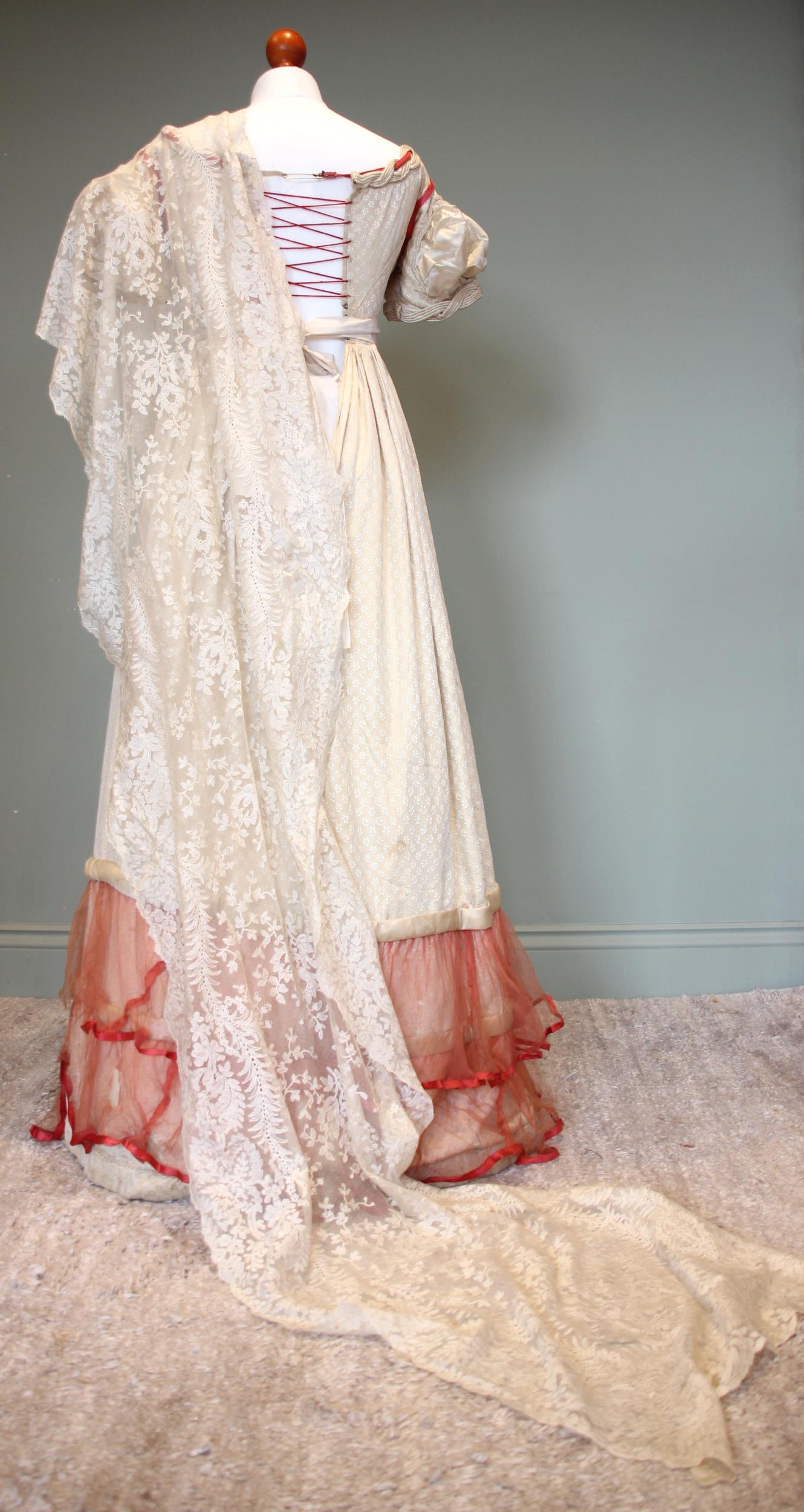 A Regency cream figured silk evening dress, circa 1815-1820, the short ...