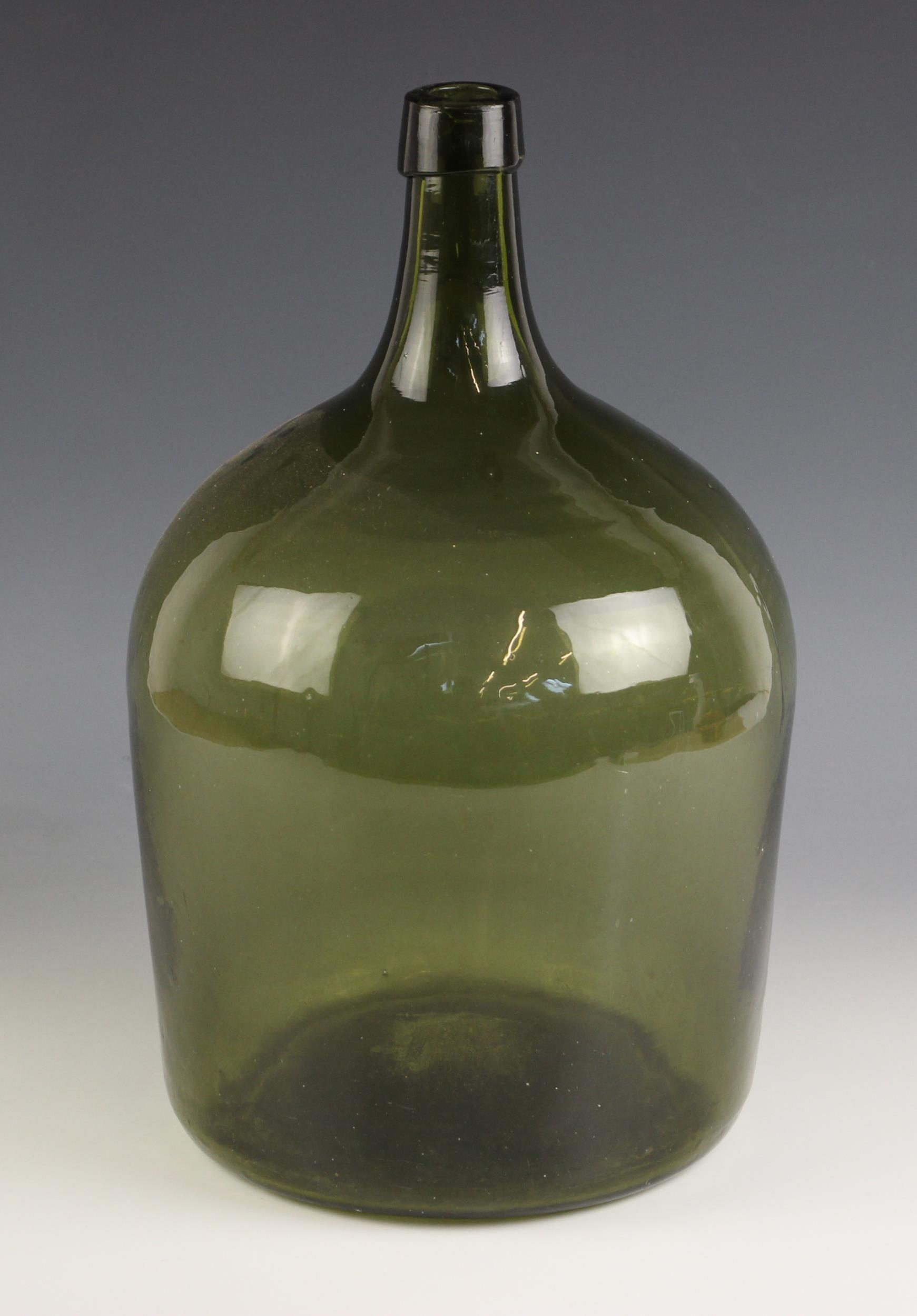 A green glass flagon, 19th century, of handle-less form, the tapering ...