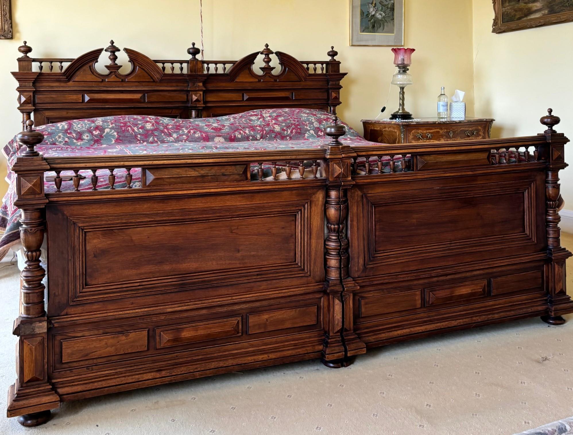 A French walnut super king-size bed, early 20th century, constructed as ...