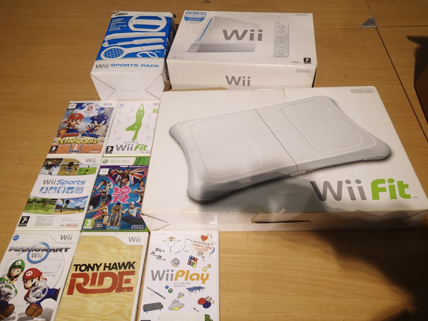 Nintendo WII with PSU, two pads with extension pads, sensor, TV cables ...