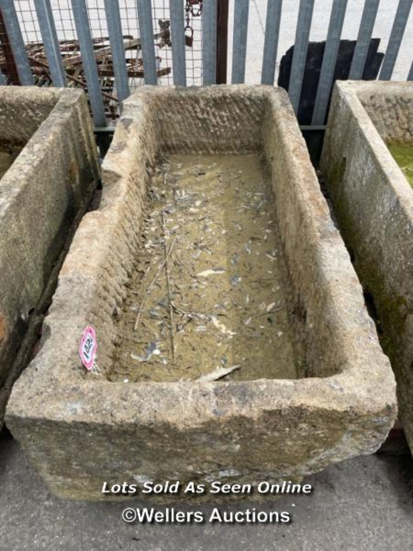 *A LARGE GRITSTONE QUARRY TROUGH, 45CM (H) X 170CM (L) X 76CM (W)