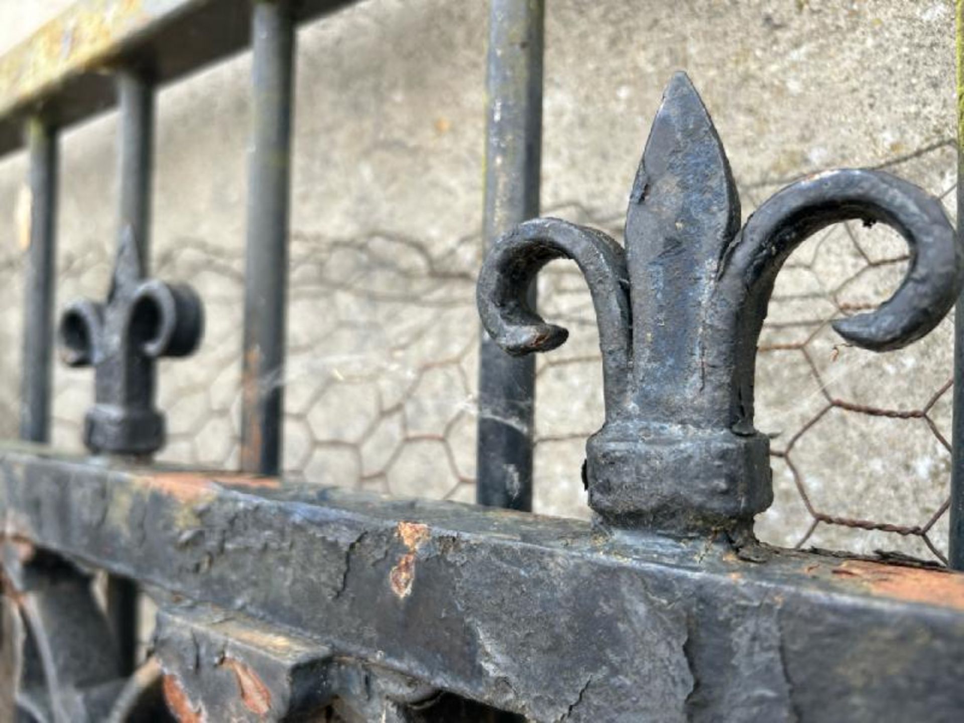 A PAIR OF HEAVY ORNATE WROUGHT IRON ENTRY GATES WITH POINTED DETAILING ...