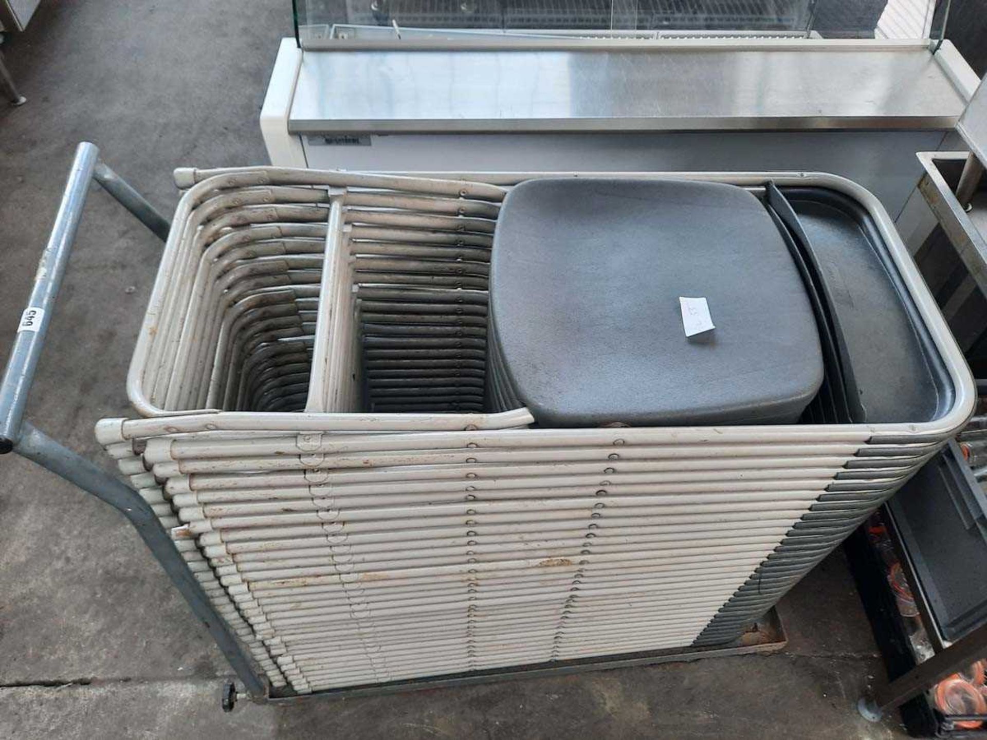 Trolley with stack of folding chairs