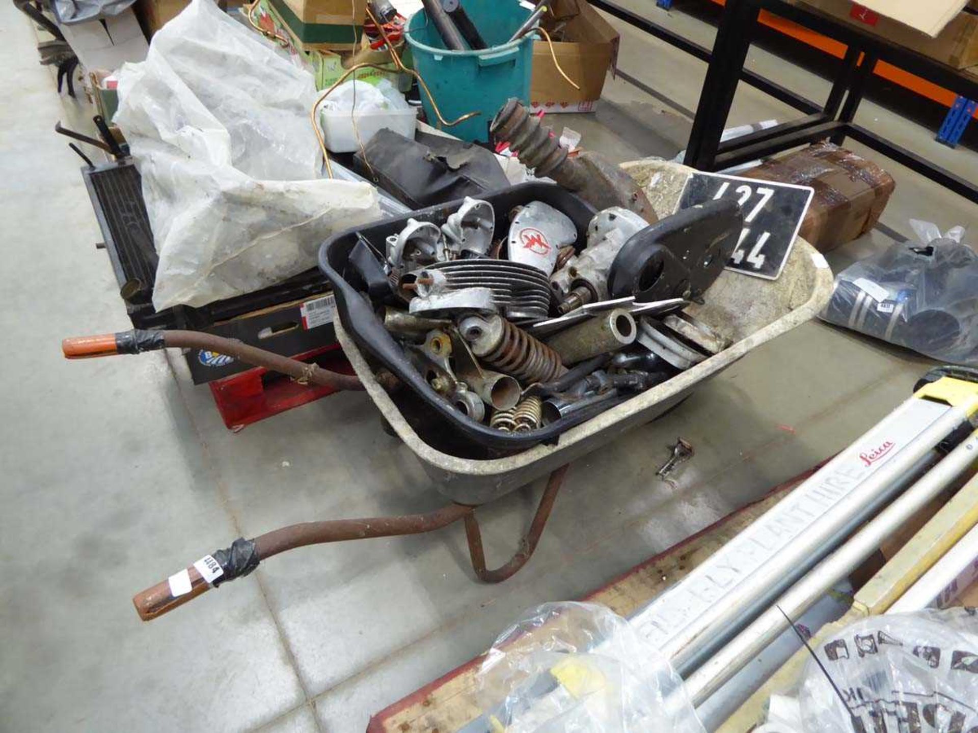 Wheelbarrow containing Matchless motorcycle engine parts and other ...