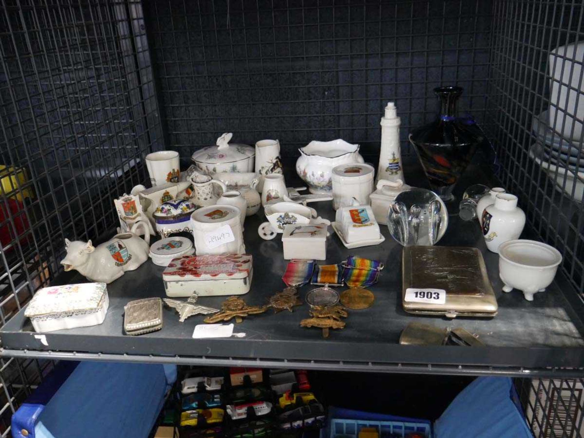 Cage containing collectible medals, match and cigarette case and ...