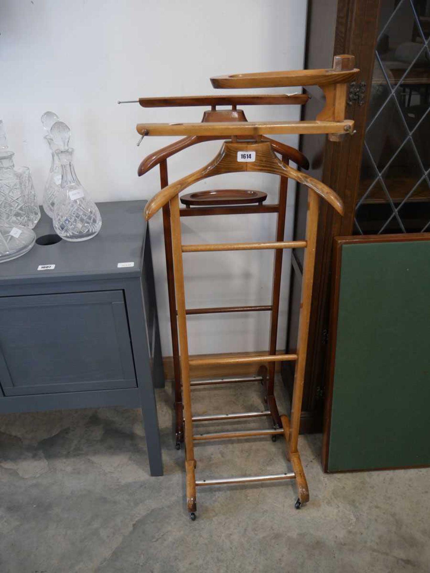 2 wooden clothes stands together with folding card table