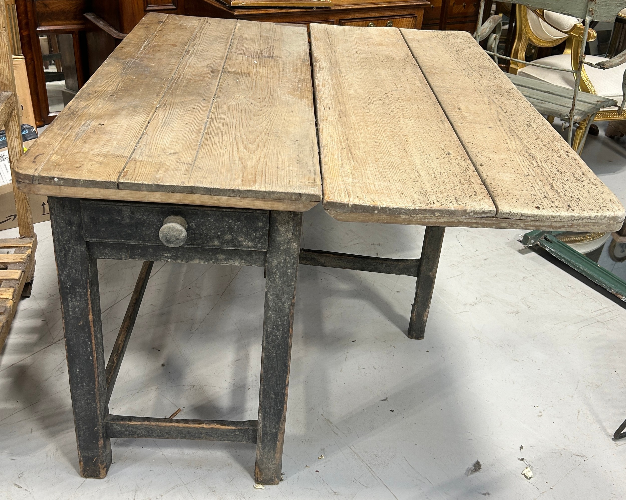 A RUSTIC PINE GATE LEG TABLE WITH EBONISED LEGS, Closed 121cm x 73cm x ...