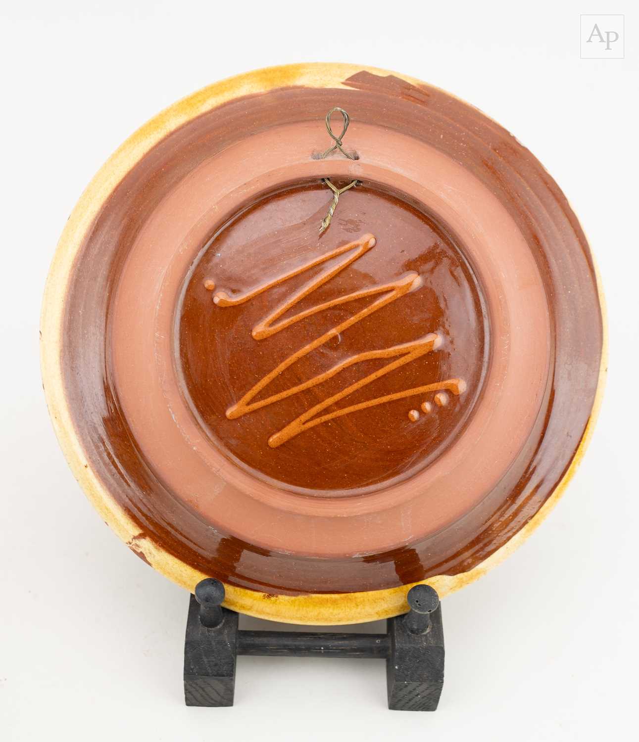 MARY WONDRAUSCH (1923-2016); a slipware cradle and baby, painted MW ...