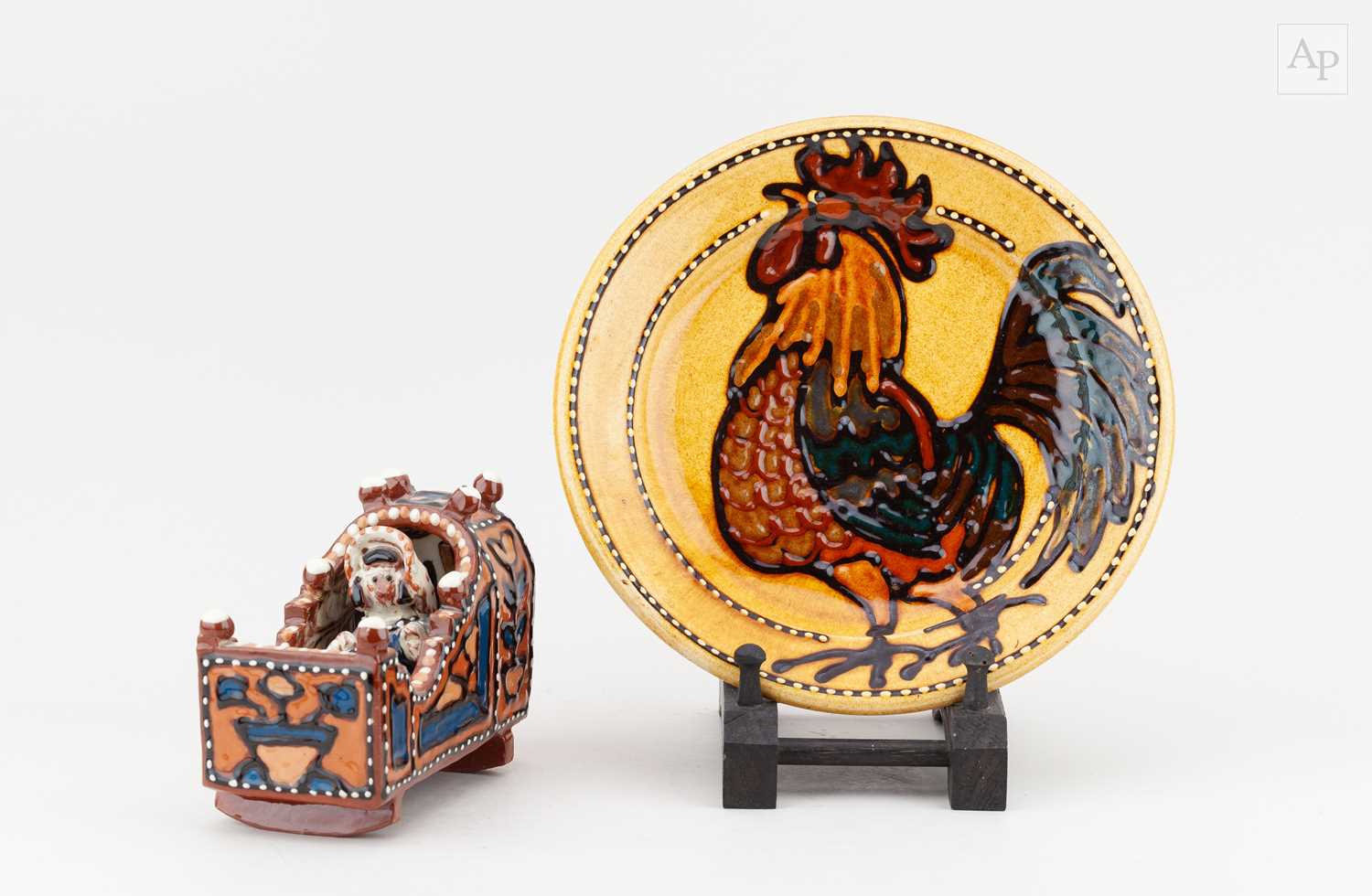 MARY WONDRAUSCH (1923-2016); a slipware cradle and baby, painted MW ...