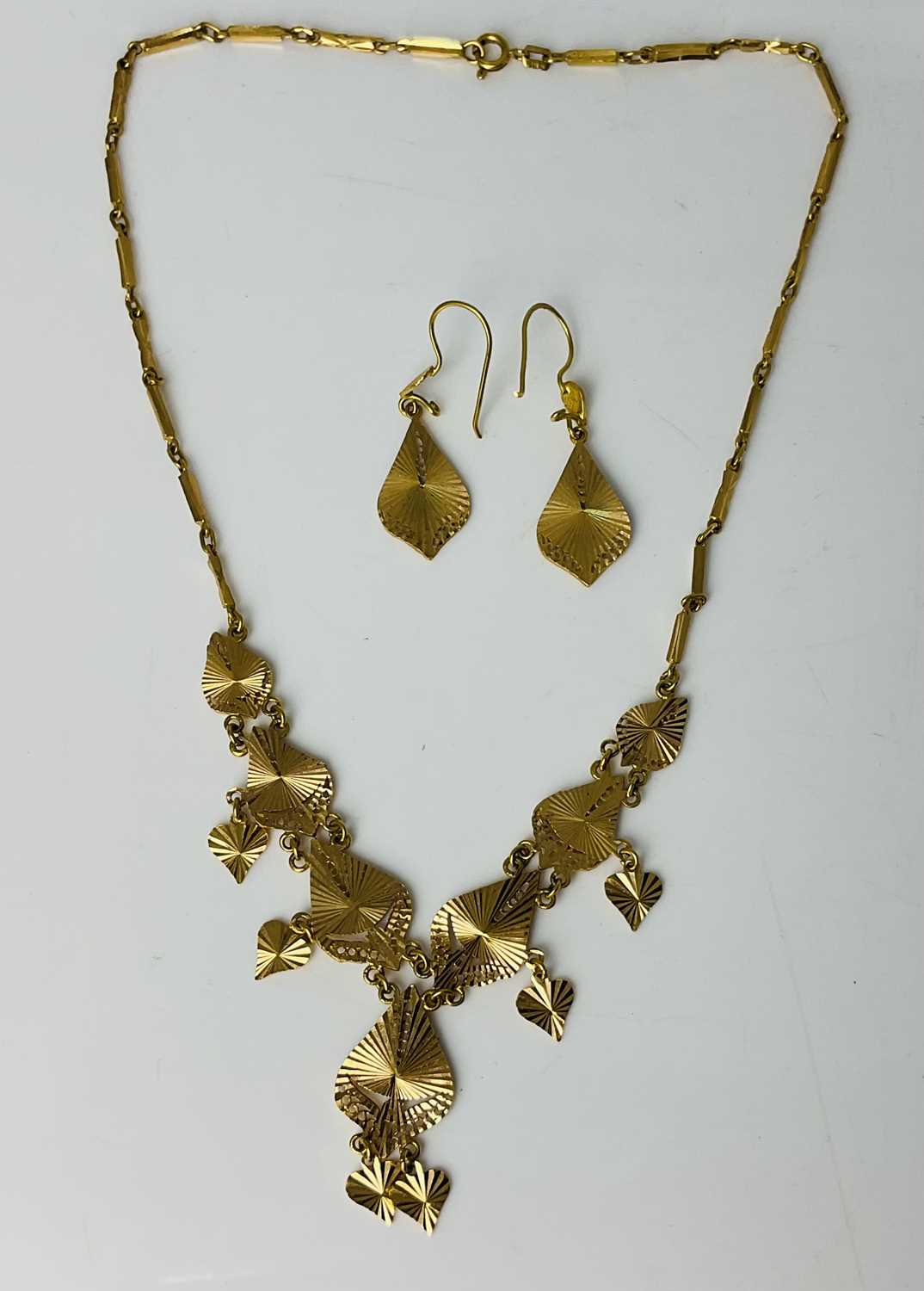 A 21ct gold Middle Eastern necklace, length 42.5cm, and a pair of ...