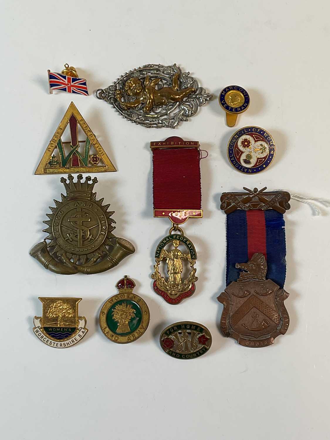 A small group of vintage badges and medallions.