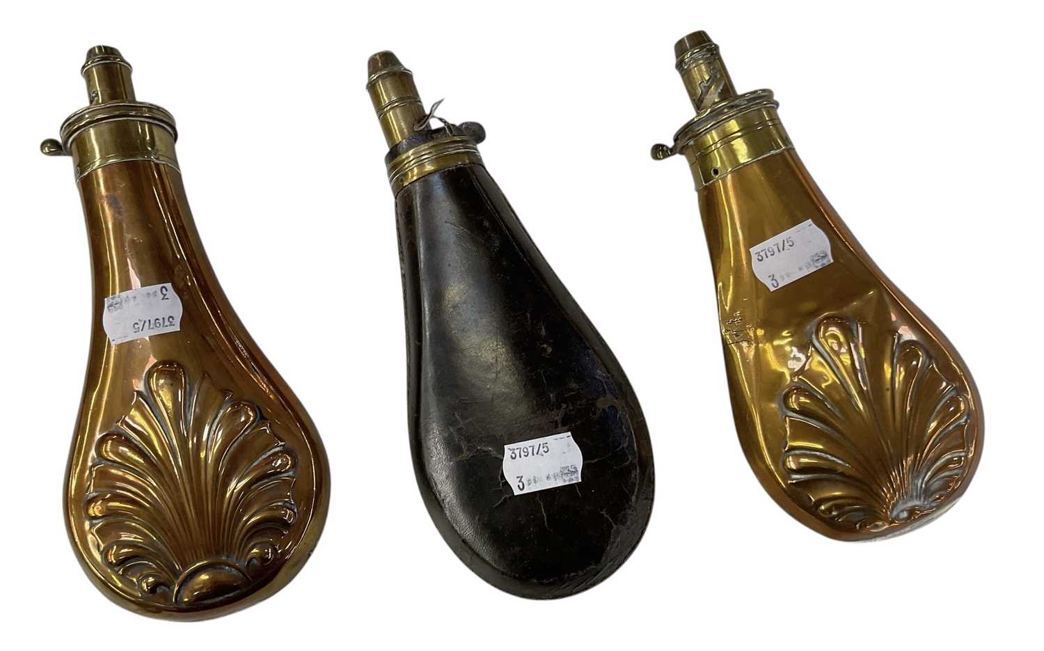 A pair of 19th century copper powder flasks, with shell decoration ...