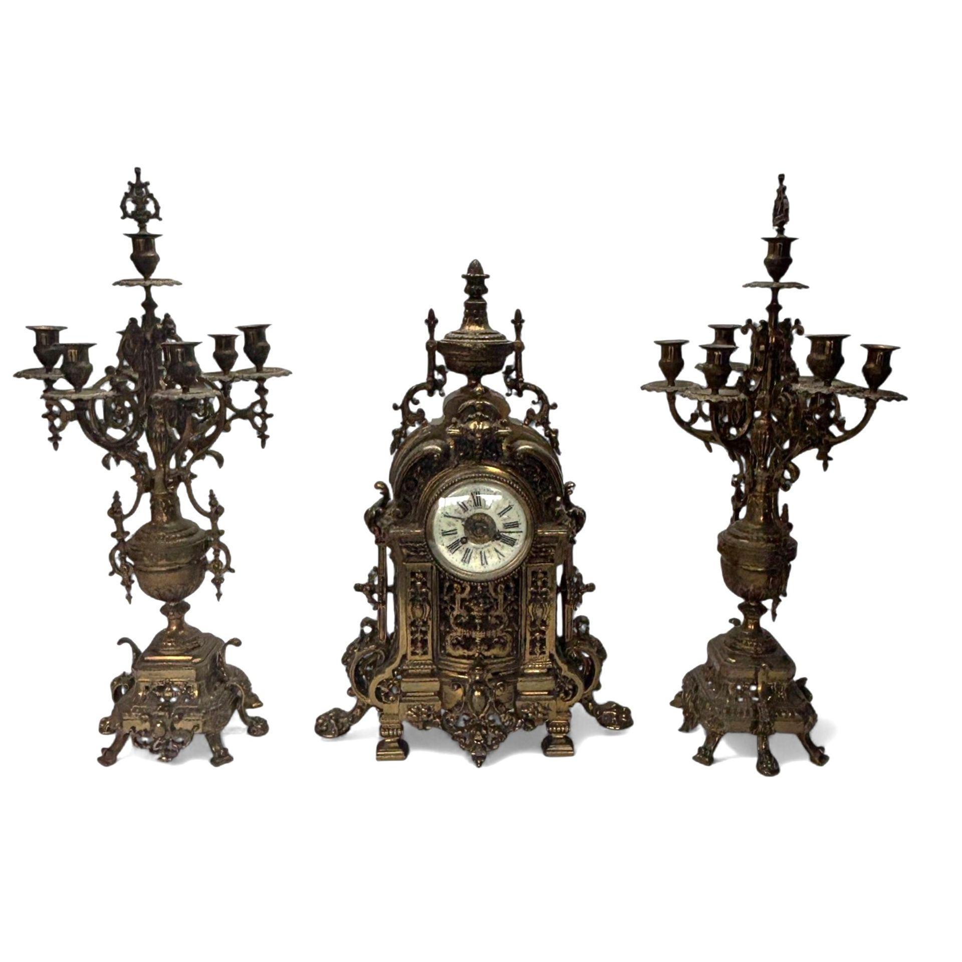 An antique 19th-century French bronze clock with two seven-light candle ...