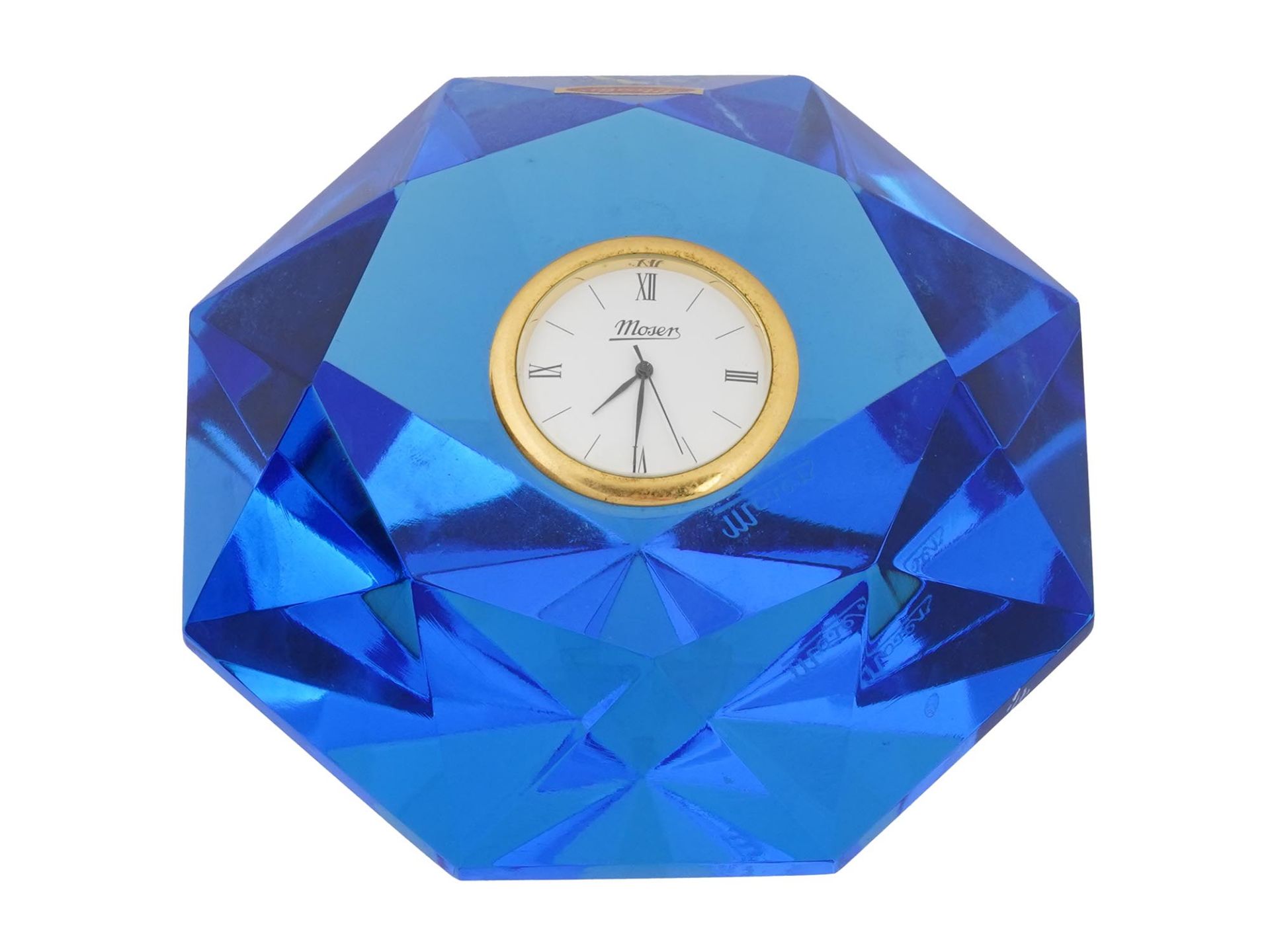 A crystal table clock by Moser, a Czech luxury glassware company ...