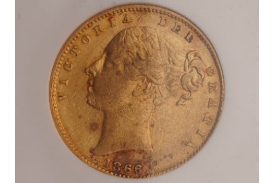 An antique United Kingdom sovereign gold coin, 1866. Coat of arms on ...