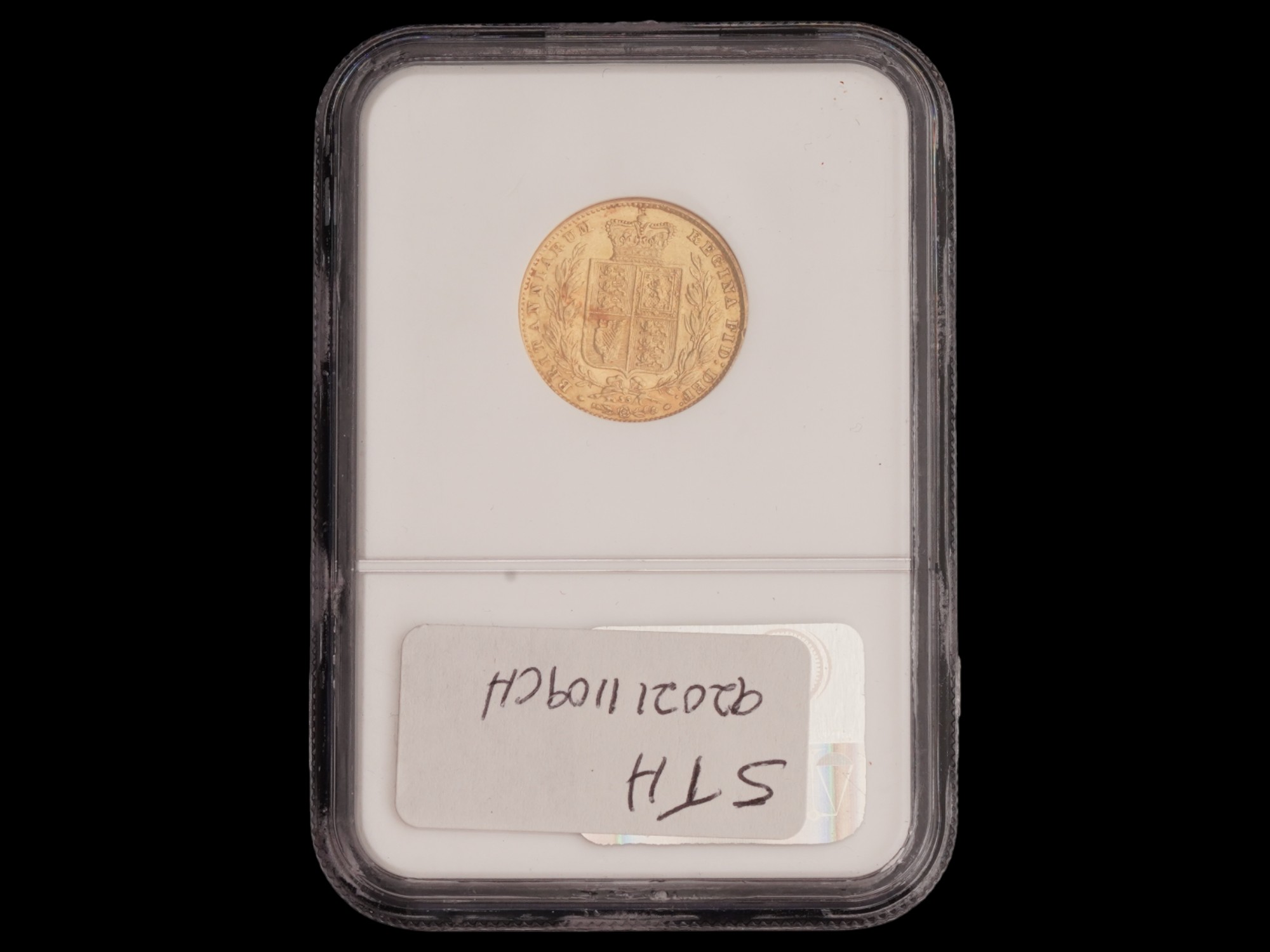 An antique United Kingdom sovereign gold coin, 1866. Coat of arms on ...