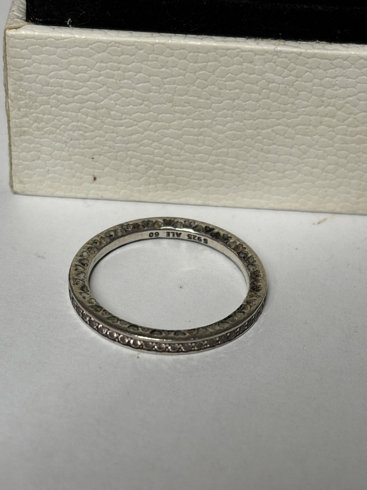 A SILVER PANDORA RING IN A PRESENTATION BOX