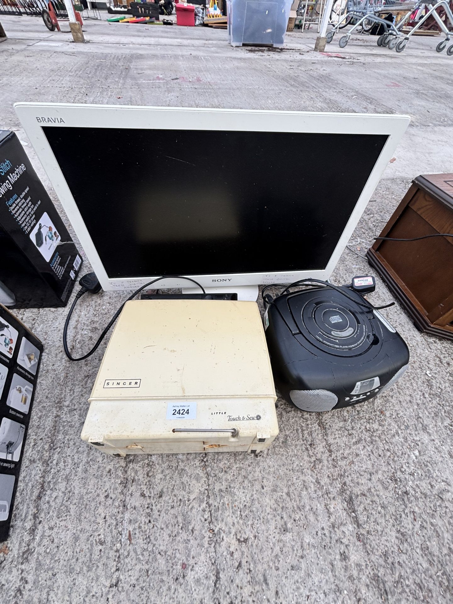 A TELEVISION, CD PLAYER AND SINGER SEWING MACHINE