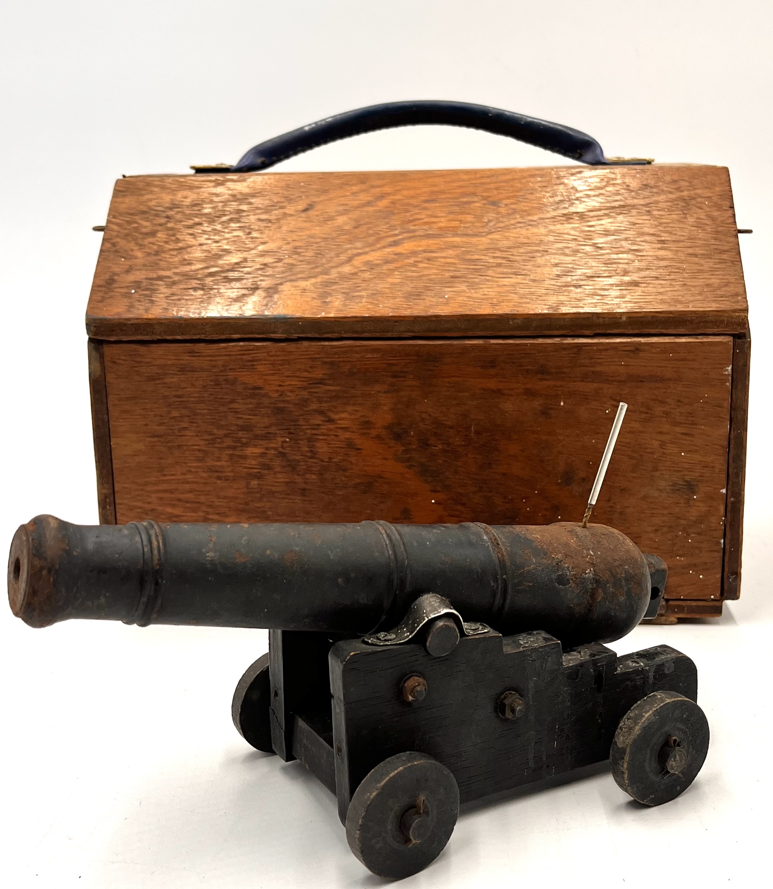 A live firing desk cannon mounted on a wooden carriage with wheels ...