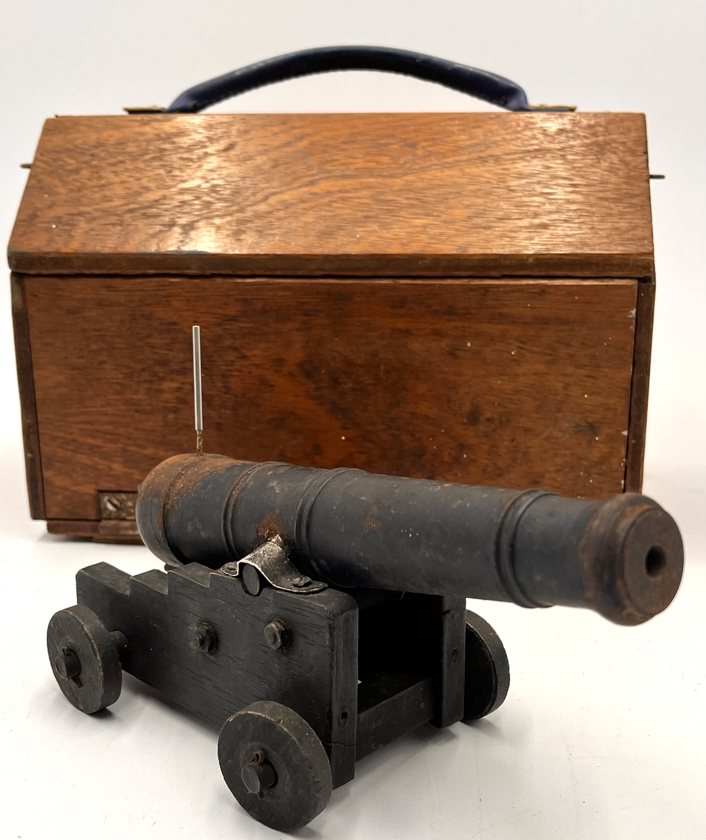 A live firing desk cannon mounted on a wooden carriage with wheels ...
